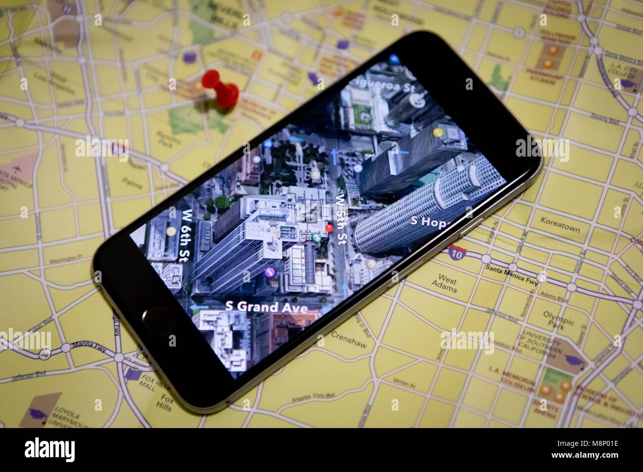 iPhone with Apple Map app displaying a three-dimensional satellite view ...