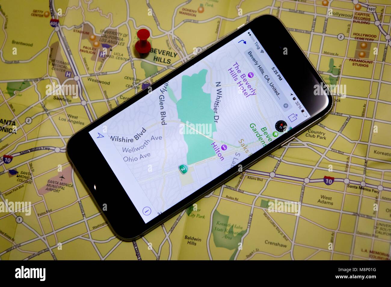 iPhone with Apple Map app, sitting on an conventional street-map, in ...