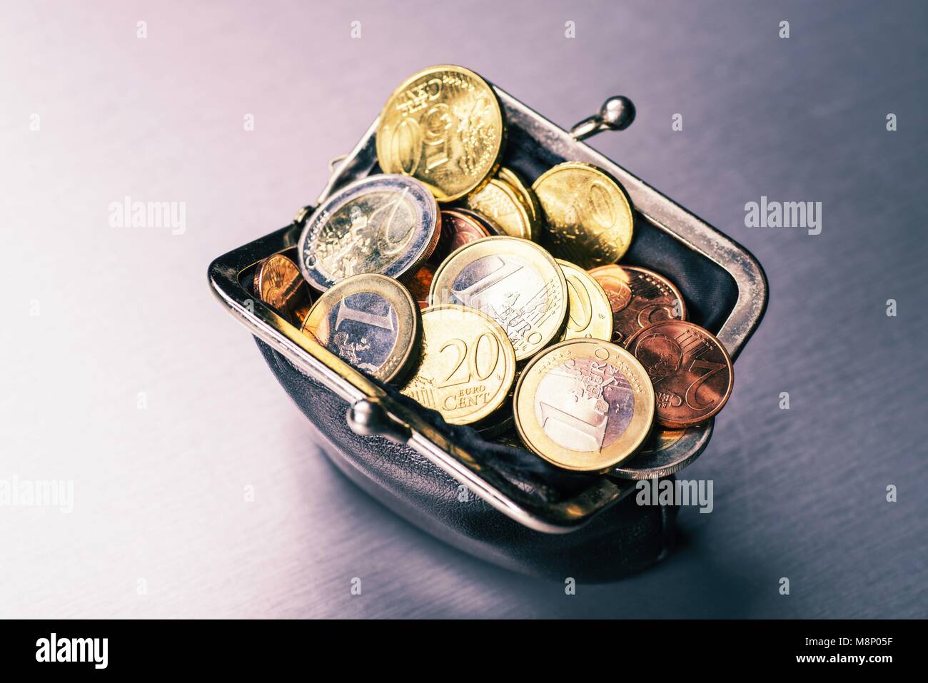 Wallet filled with many coins | usage worldwide Stock Photo - Alamy