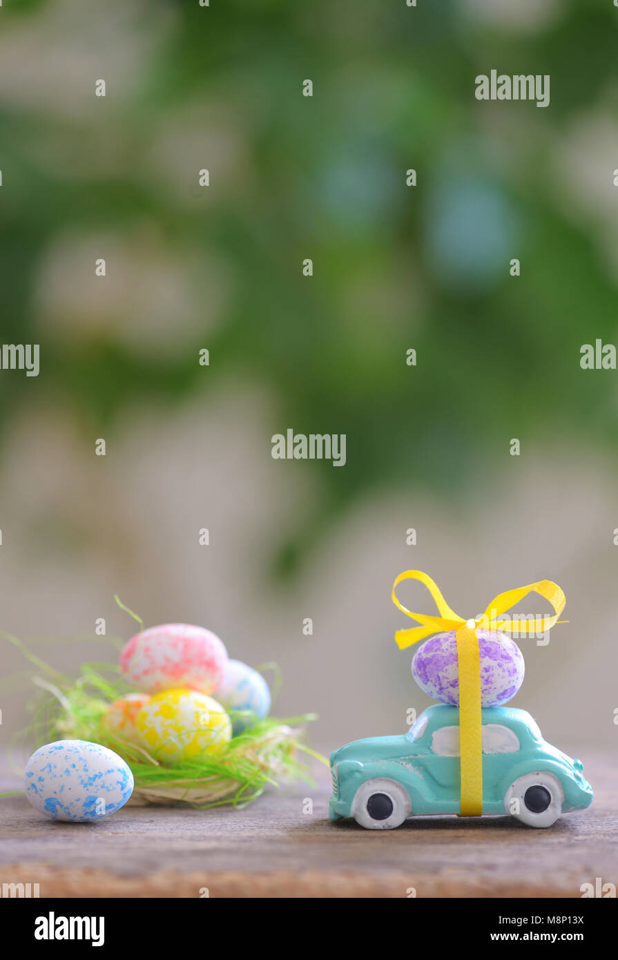 Toy car carrying easter egg in spring time Stock Photo - Alamy