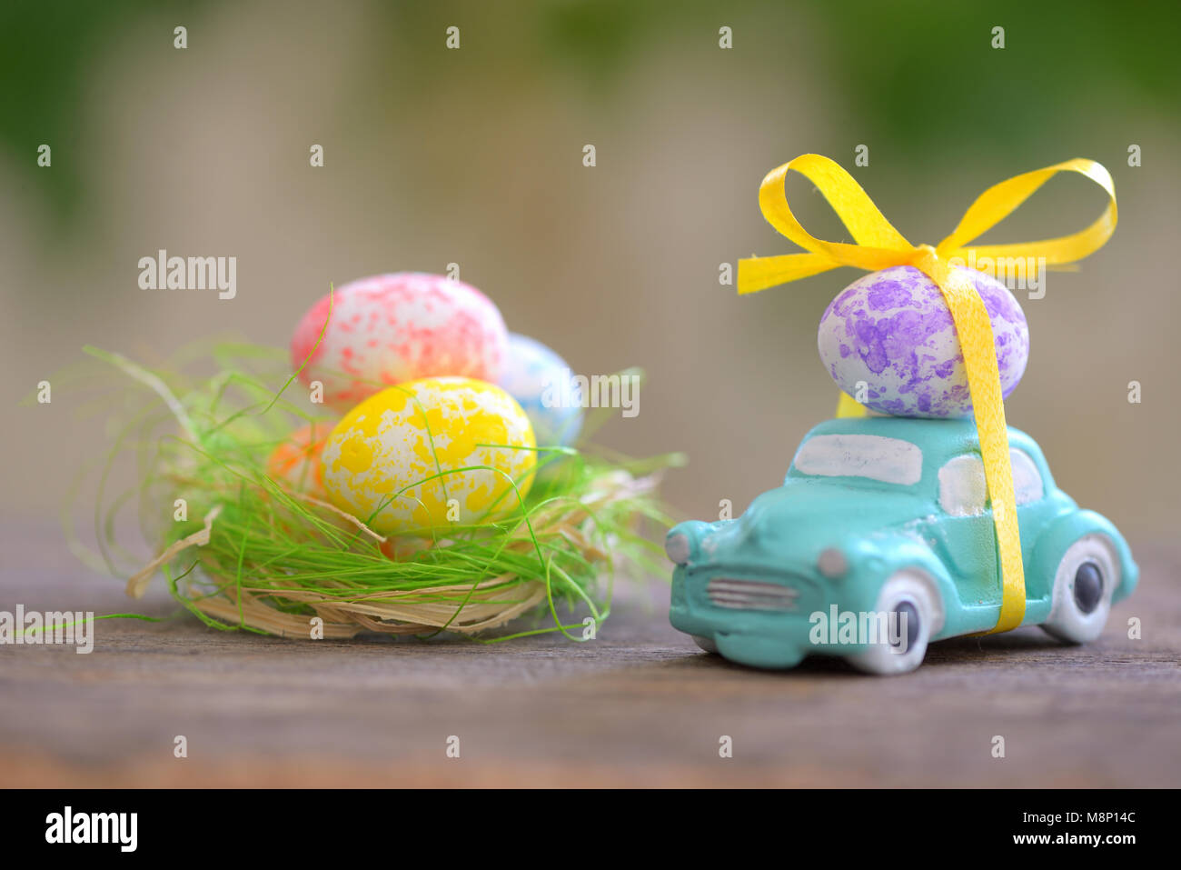 Toy car carrying easter egg in spring time Stock Photo - Alamy