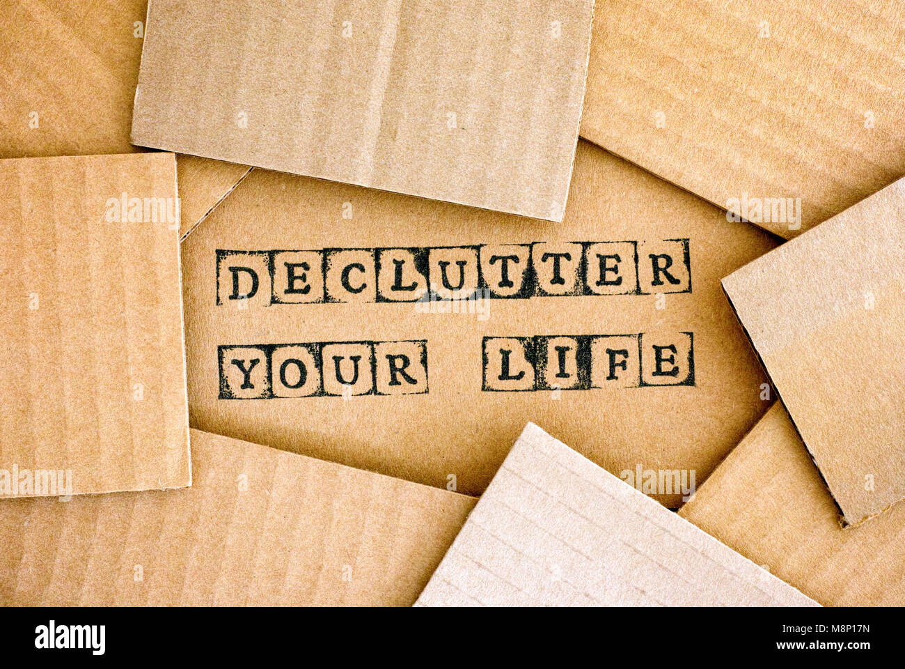 Words Declutter Your Life make by black alphabet stamps on cardboard ...