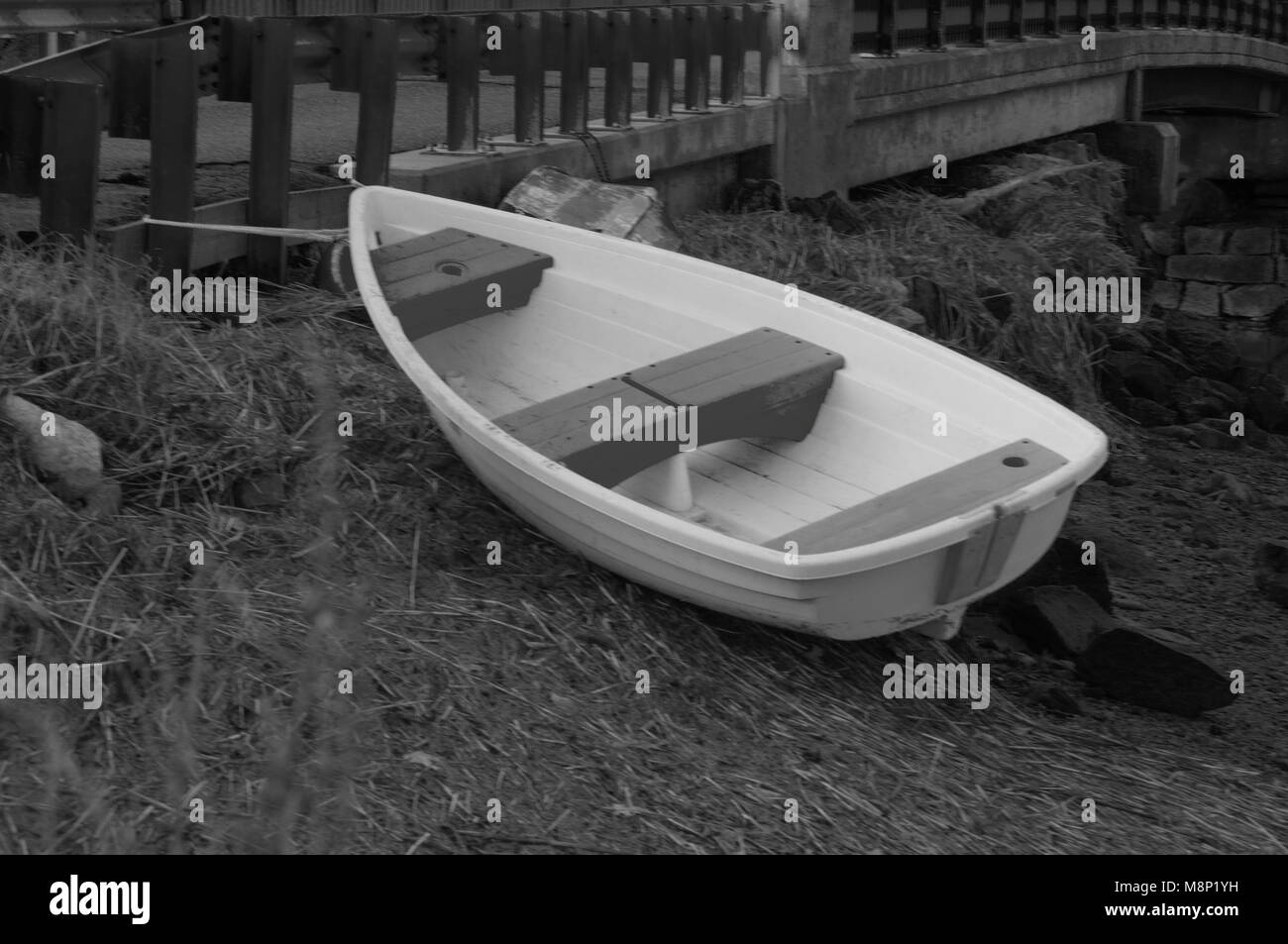 Lap streak row boat washed ashore in a storm Stock Photo - Alamy