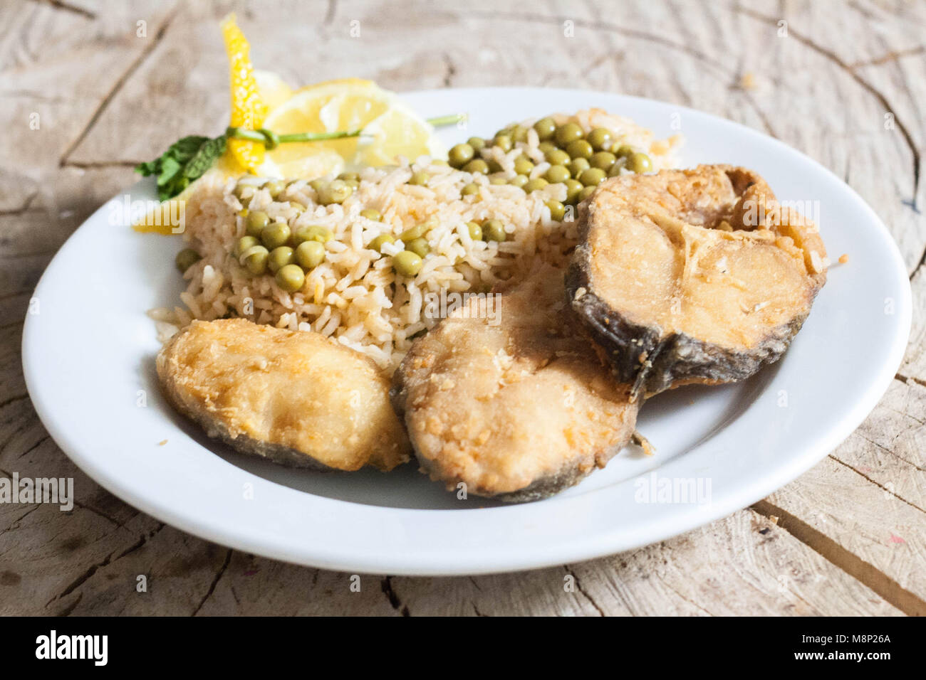 Fried Hake and pea rice Stock Photo - Alamy