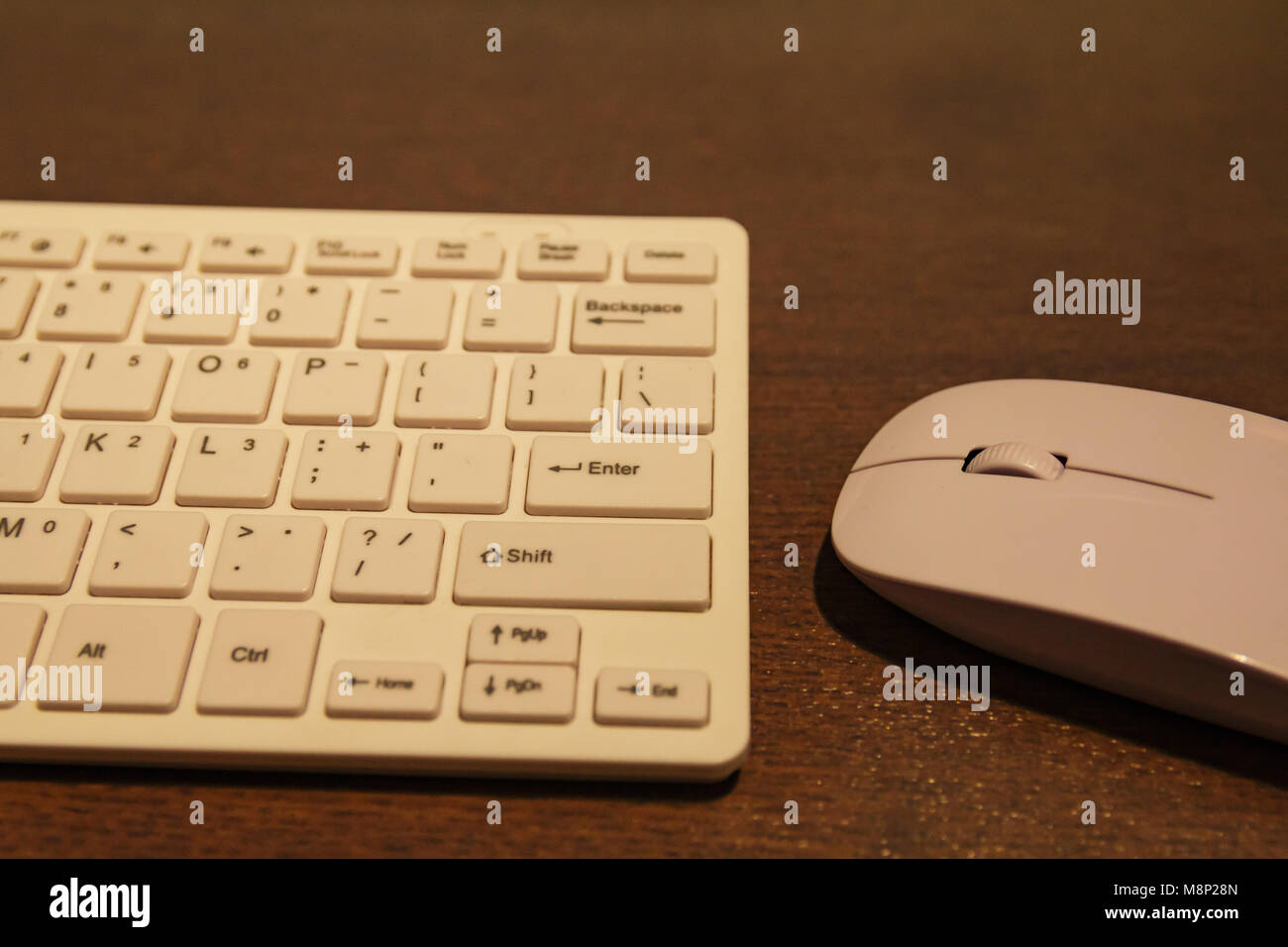 white wireless mouse and keyboard on the desk Stock Photo - Alamy
