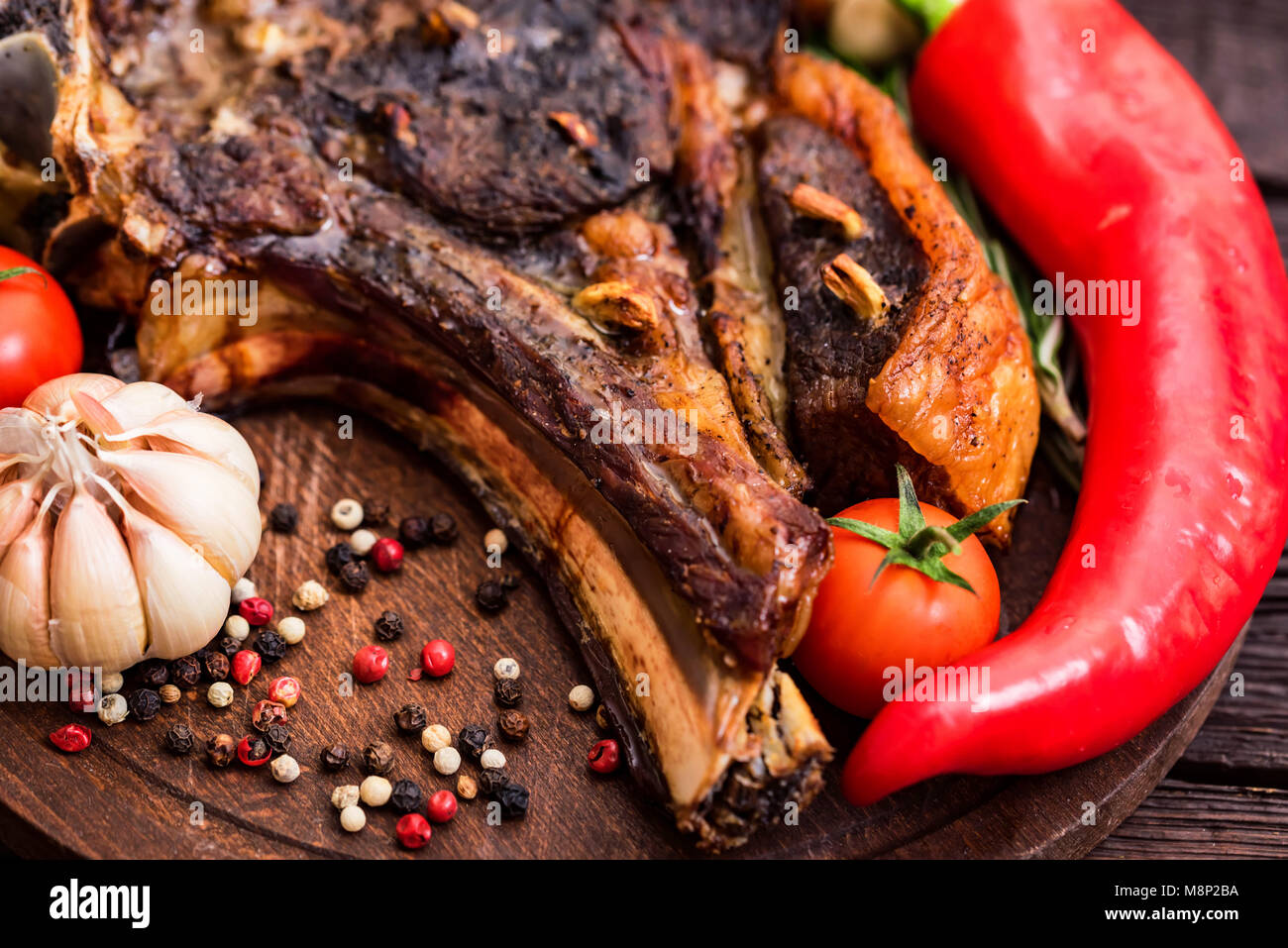 Tasty beef steak with spices and vegetables close Stock Photo - Alamy