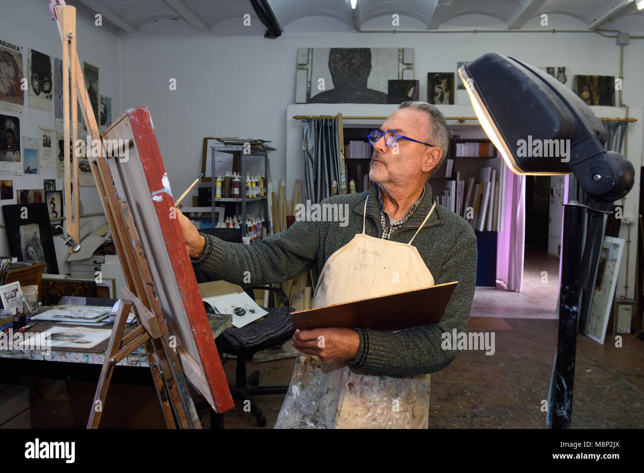 Painter artist painting a picture in the studio Stock Photo - Alamy