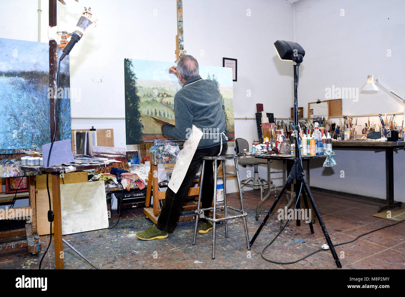 Painter artist painting a picture in the studio Stock Photo - Alamy