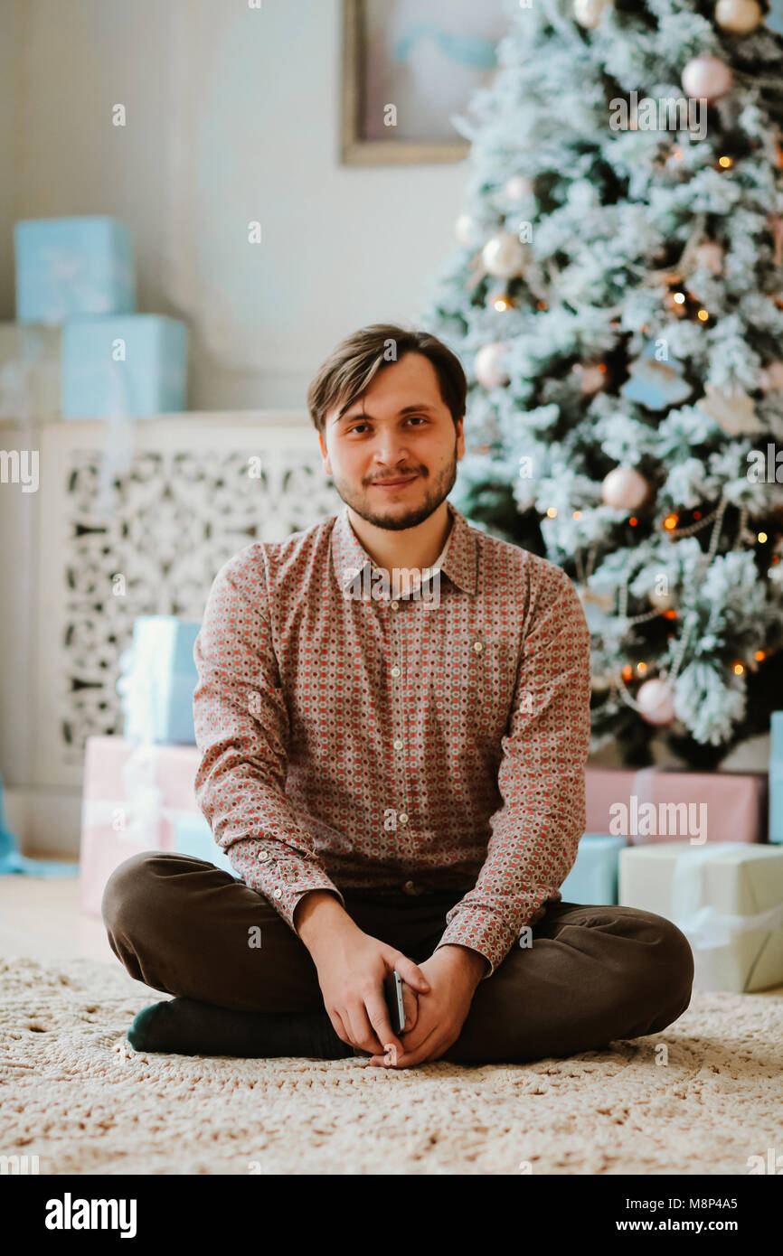 the guy is sitting on the carpet in a bright photo studio Stock Photo ...