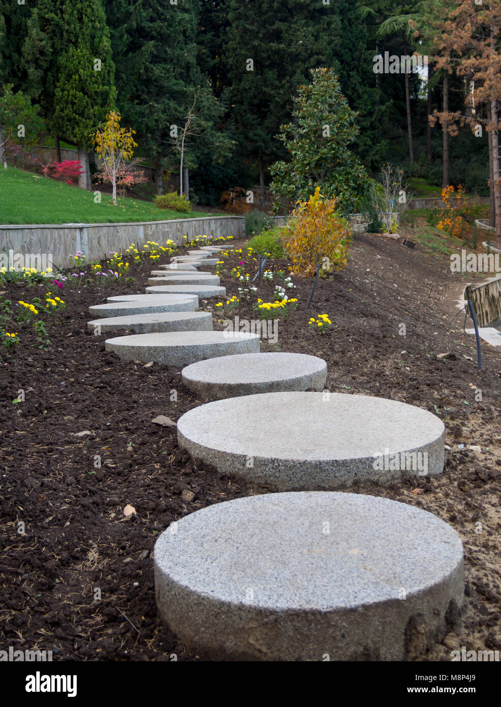 Garden paths made of circular stone slabs Stock Photo - Alamy