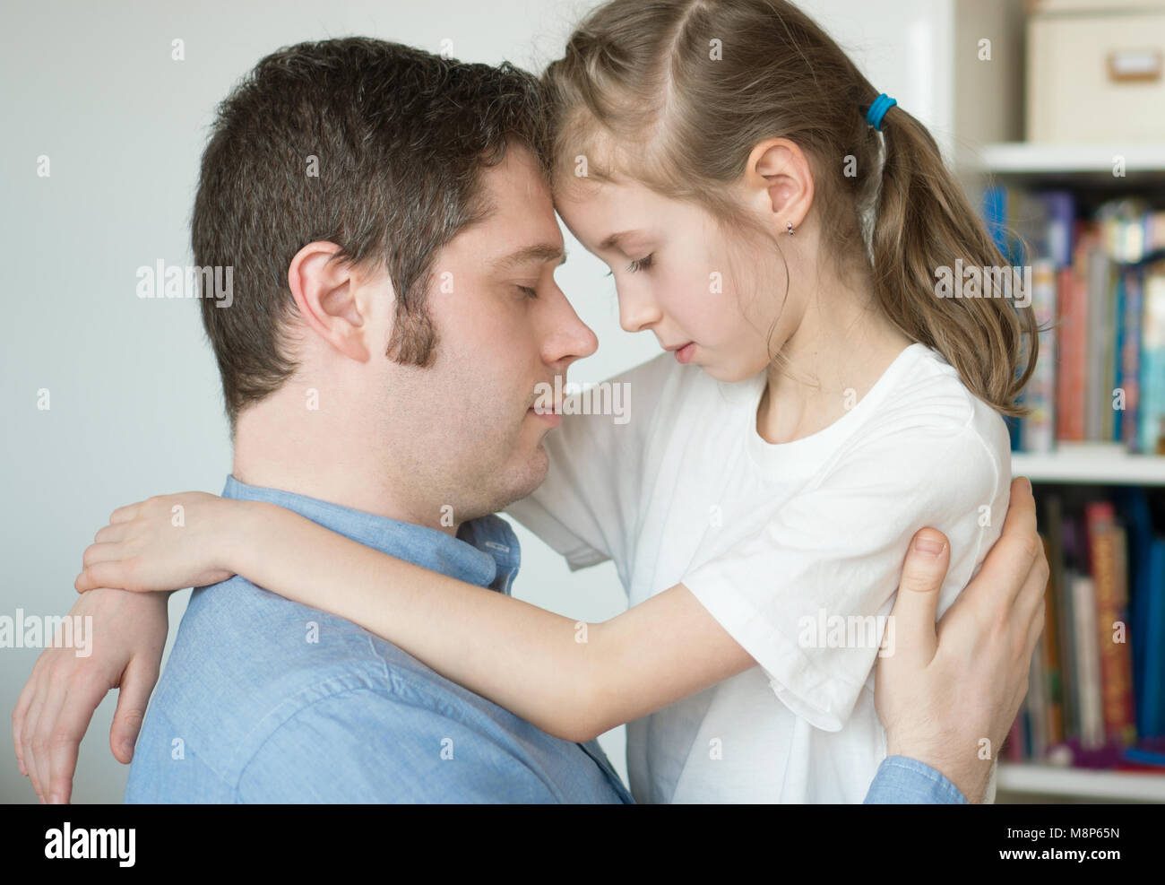 Sad little girl hugging her dad Stock Photo - Alamy