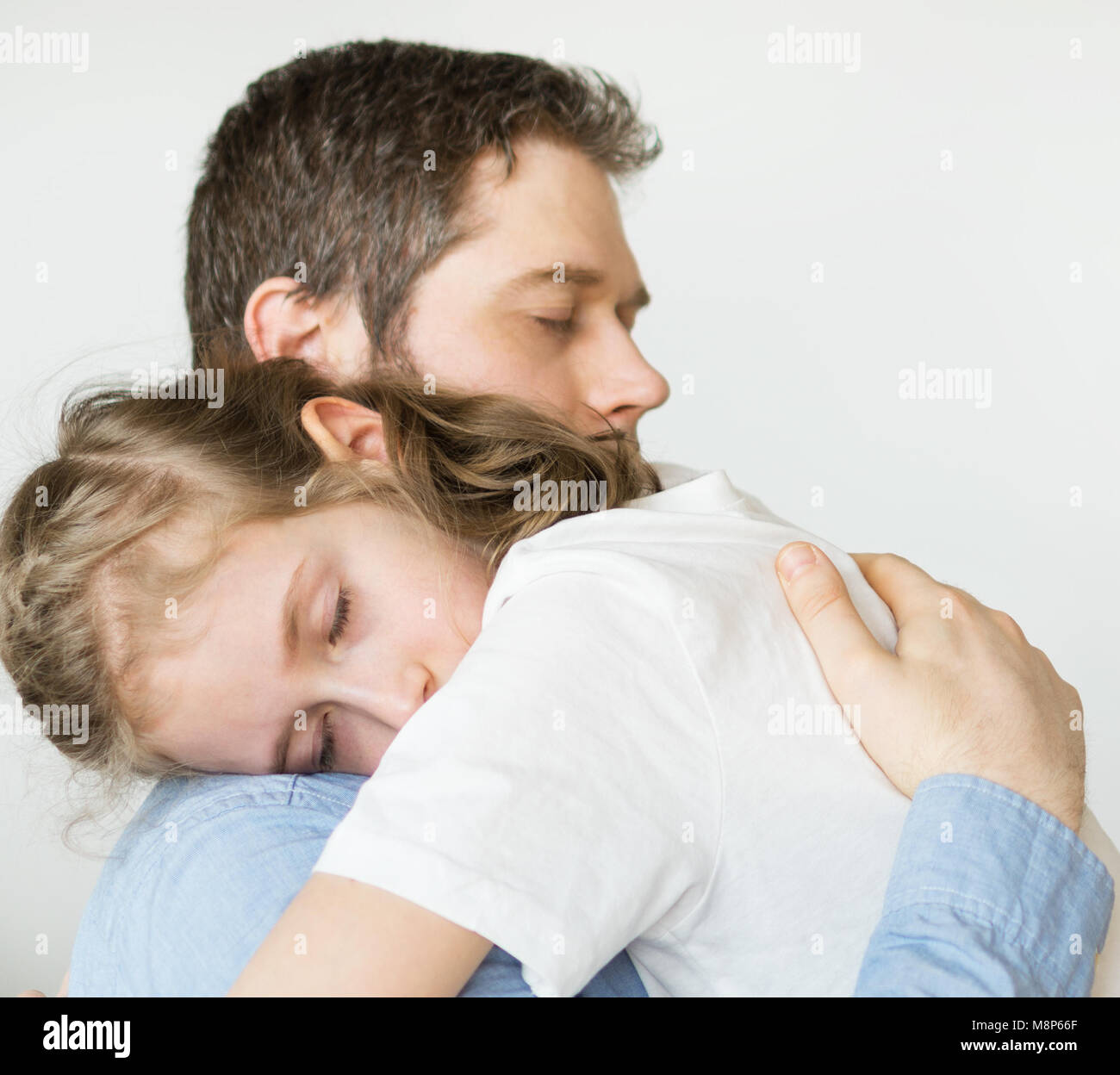Sad little girl hugging her dad Stock Photo - Alamy