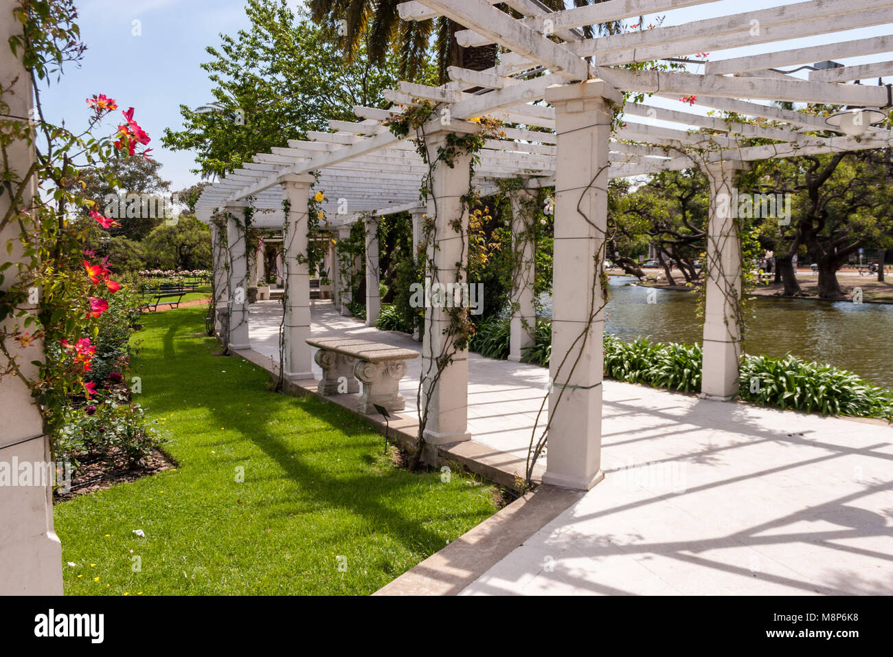 A trellis walkway with flowers in a romantic park Stock Photo - Alamy