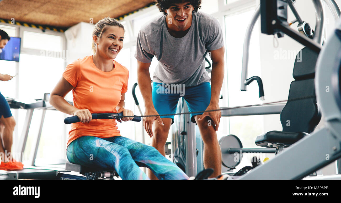 Personal trainer helping Stock Photo - Alamy