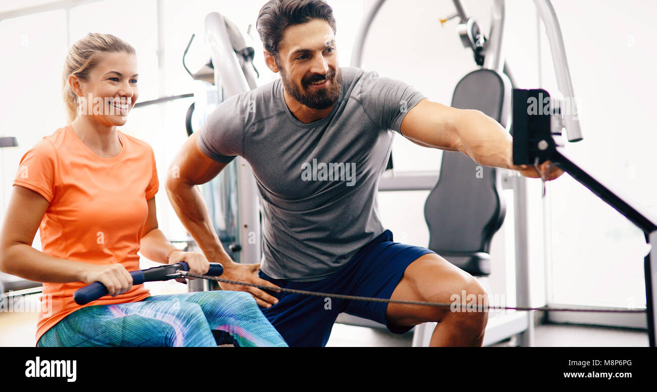 Personal trainer helping woman reach goals Stock Photo - Alamy