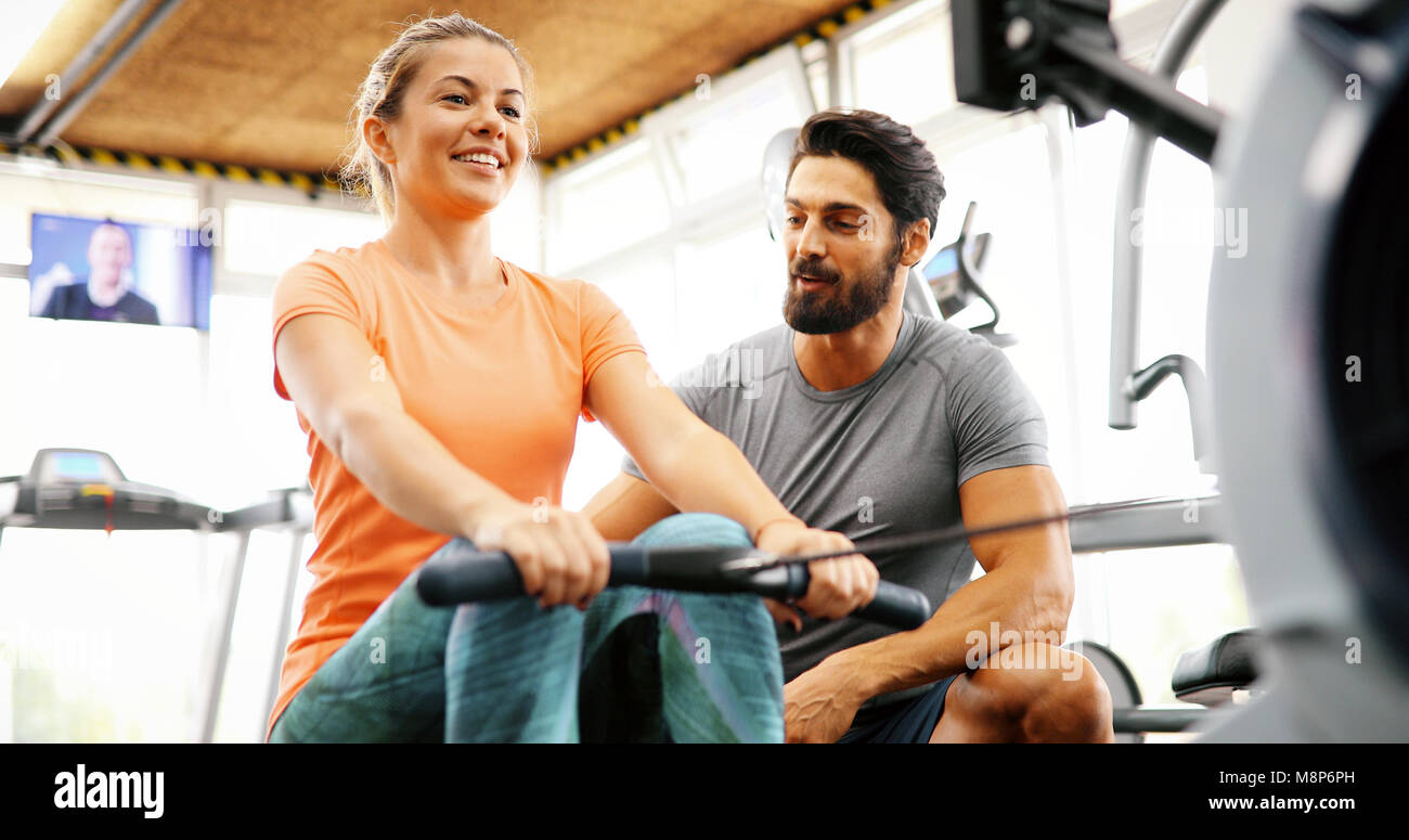 Personal trainer giving instructions in gym Stock Photo - Alamy