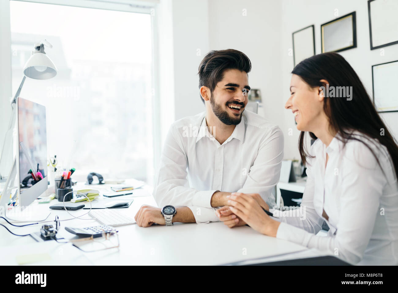 Happy colleagues casual chat at the office Stock Photo - Alamy