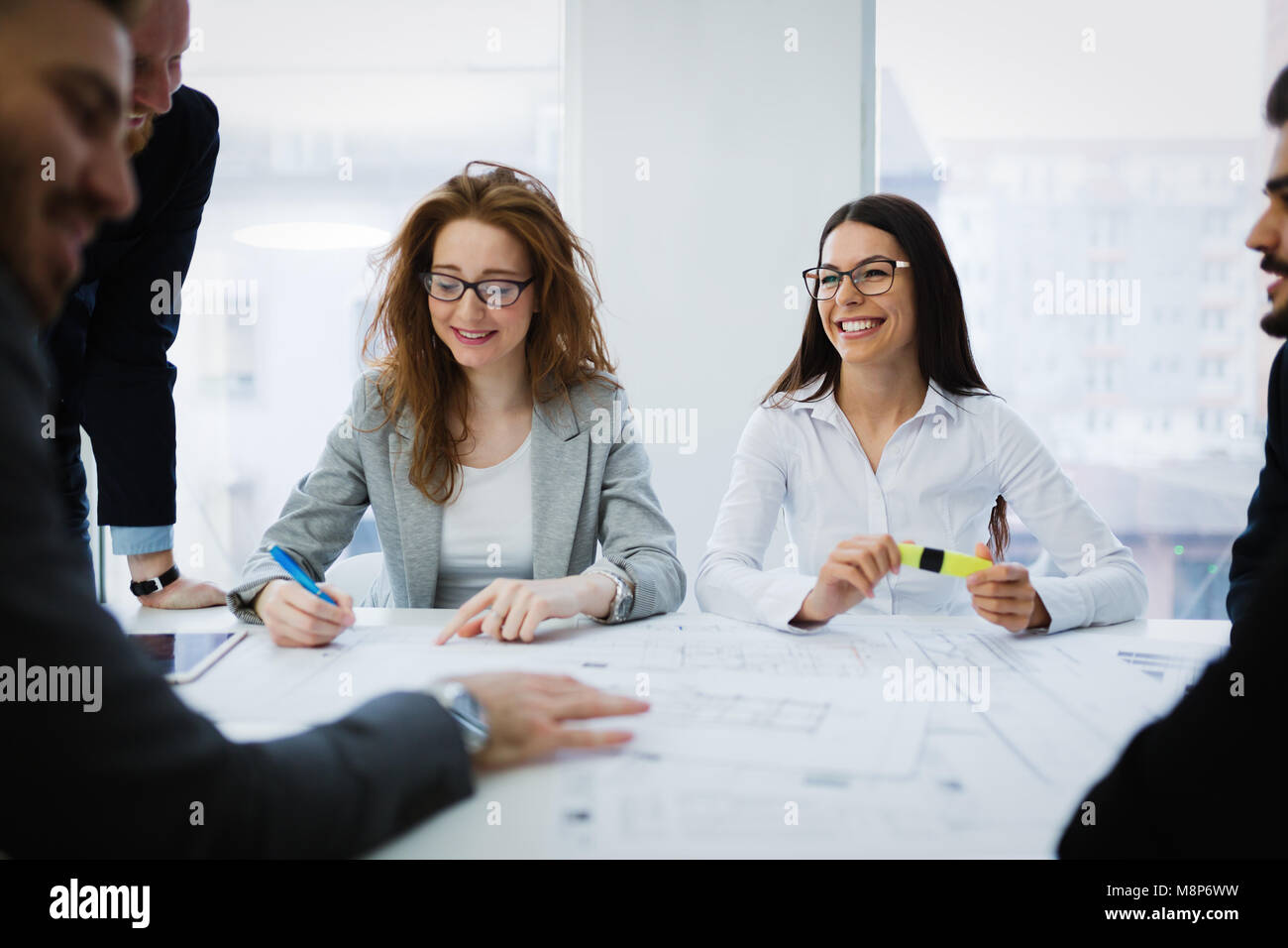 Team of architects working together on project Stock Photo - Alamy