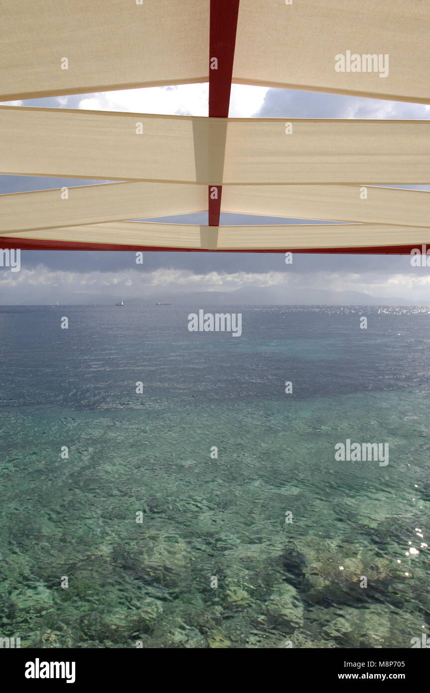 Detail of a Canopy & awning with blue sky and sea in the background ...