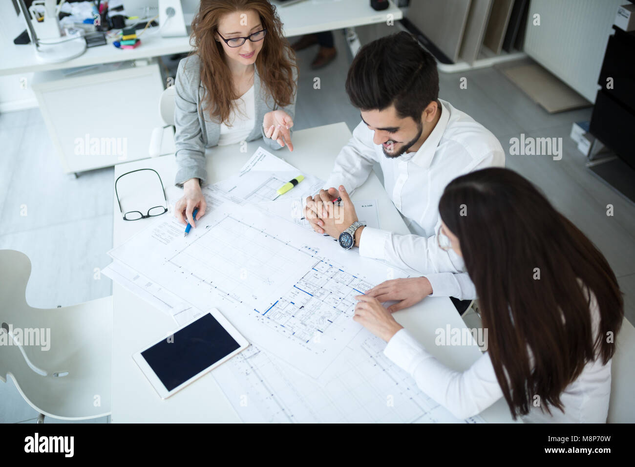 Team of architects working together on project Stock Photo - Alamy