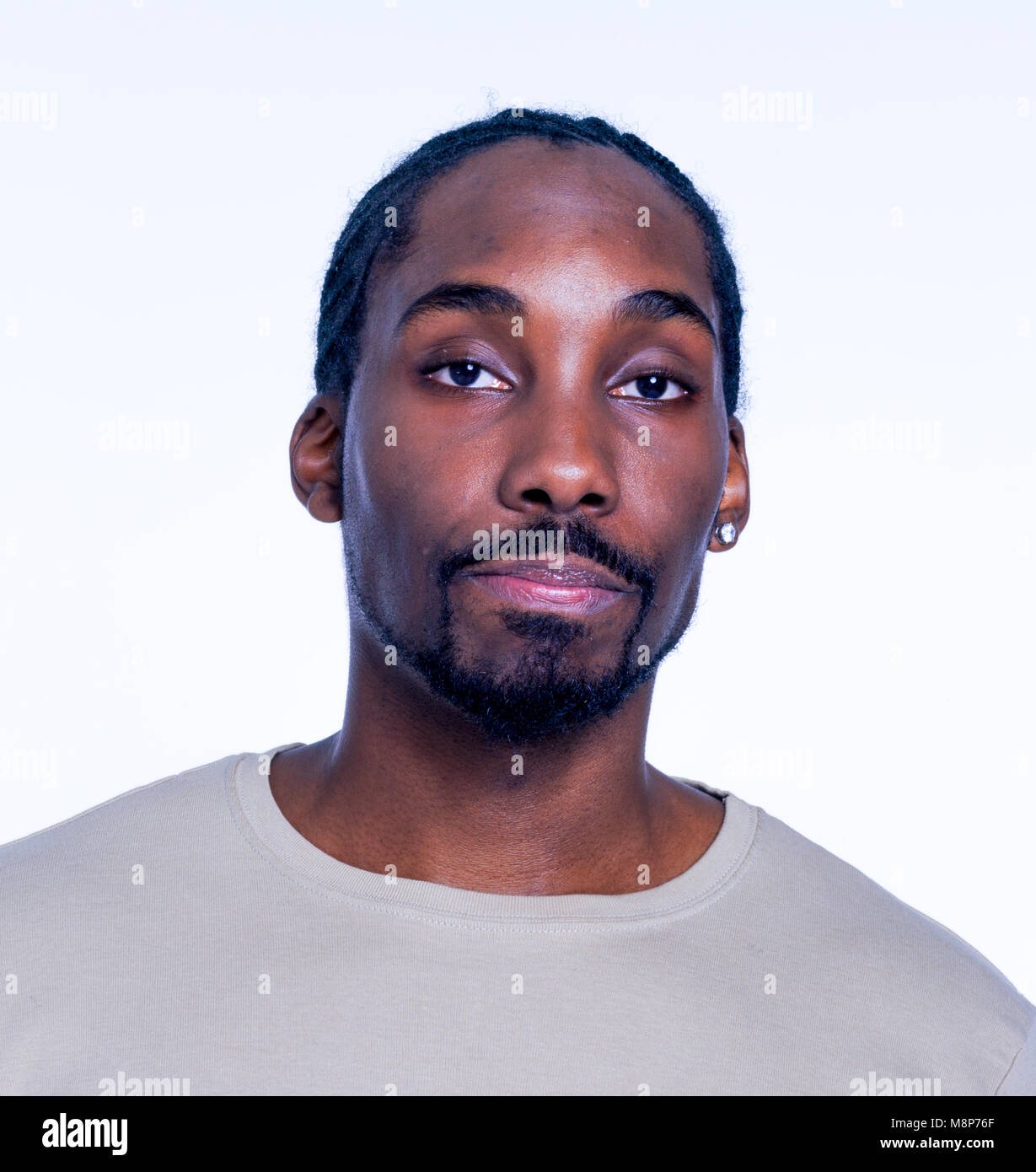Studio portrait of young black male in his twenties against neutral ...