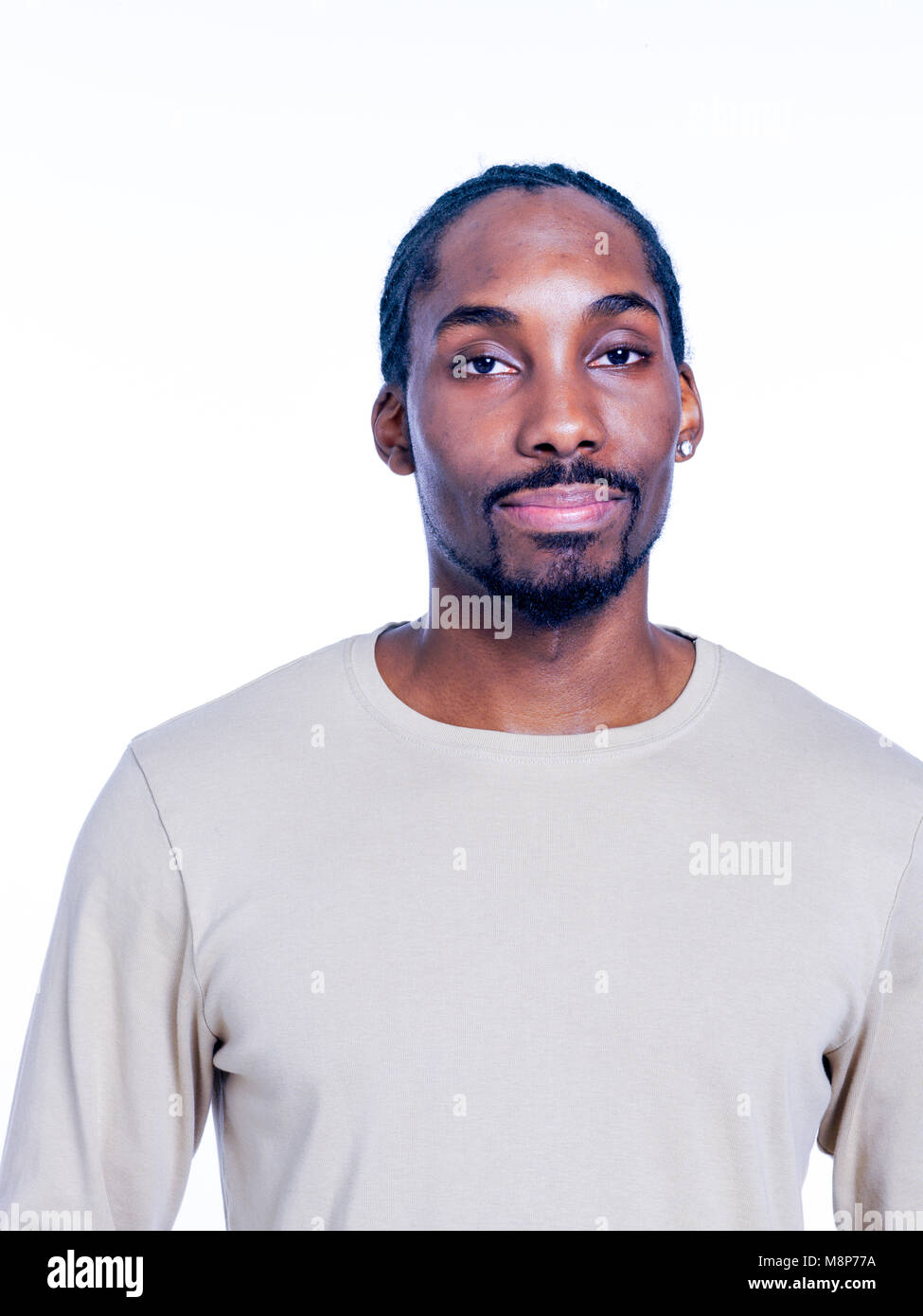 Studio portrait of young black male in his twenties against neutral ...