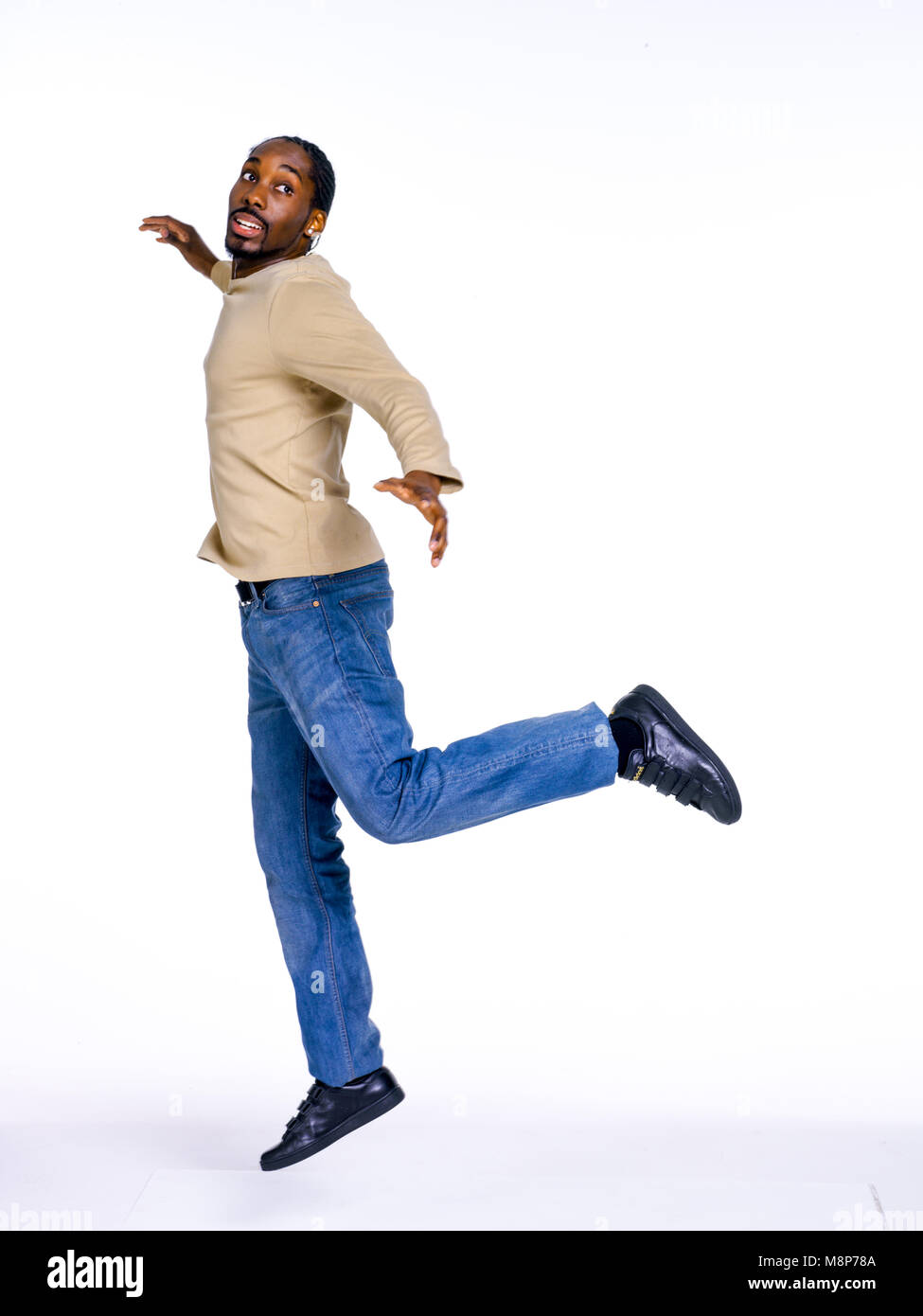 Studio portrait of young black male in his twenties against neutral ...