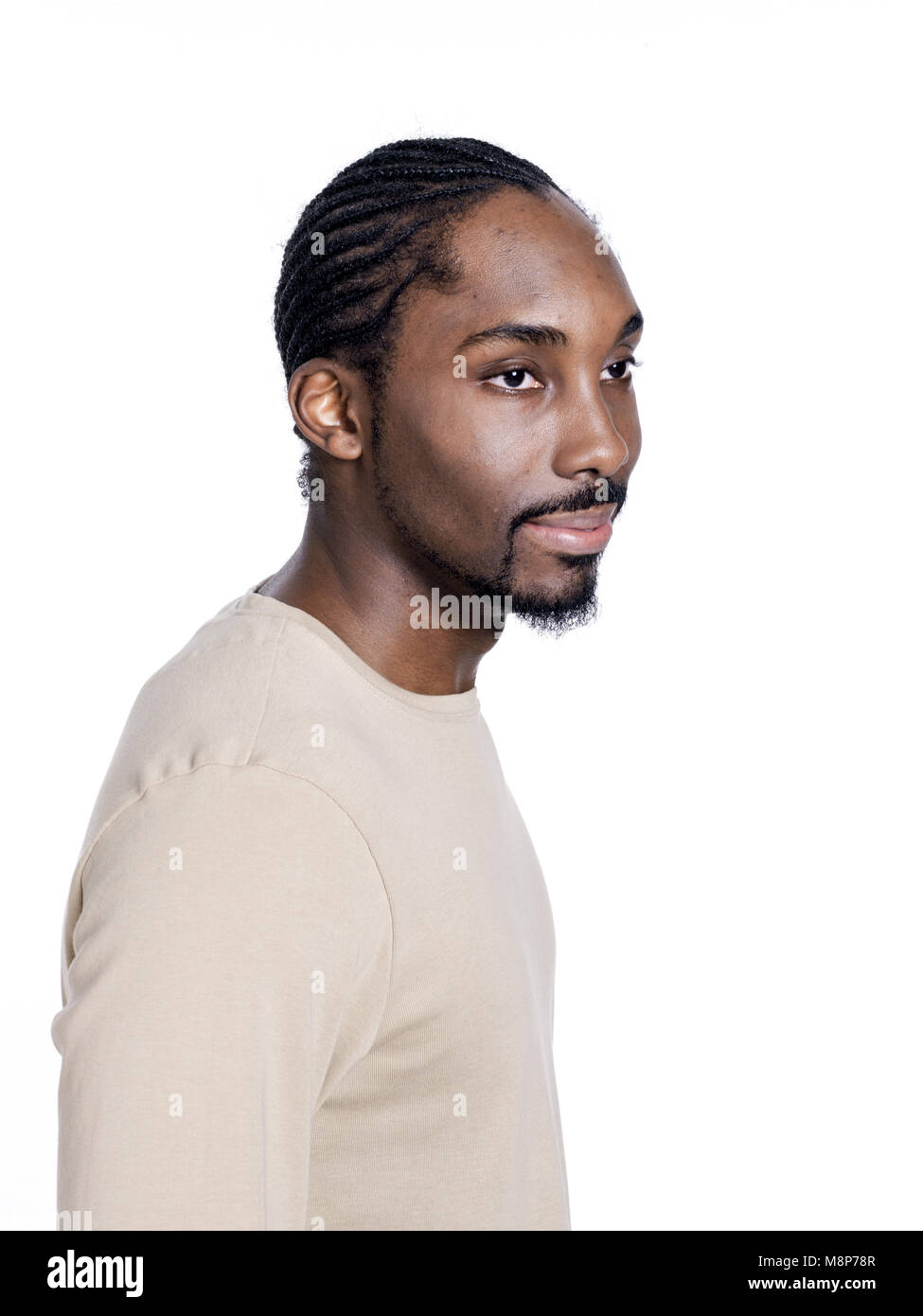 Studio portrait of young black male in his twenties against neutral ...