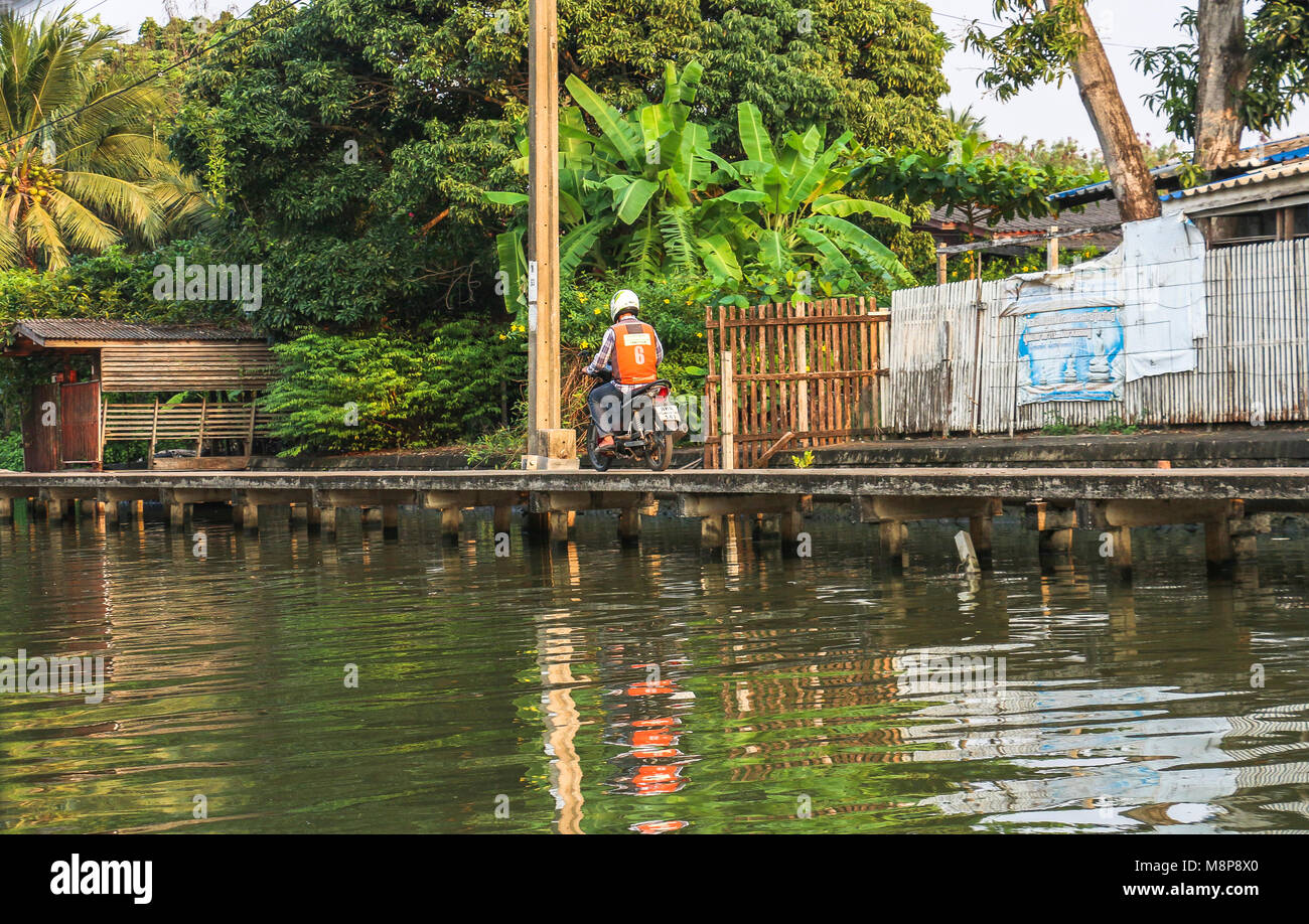 Motor bike on walkway near canal in Bangkok, Thailand Stock Photo - Alamy