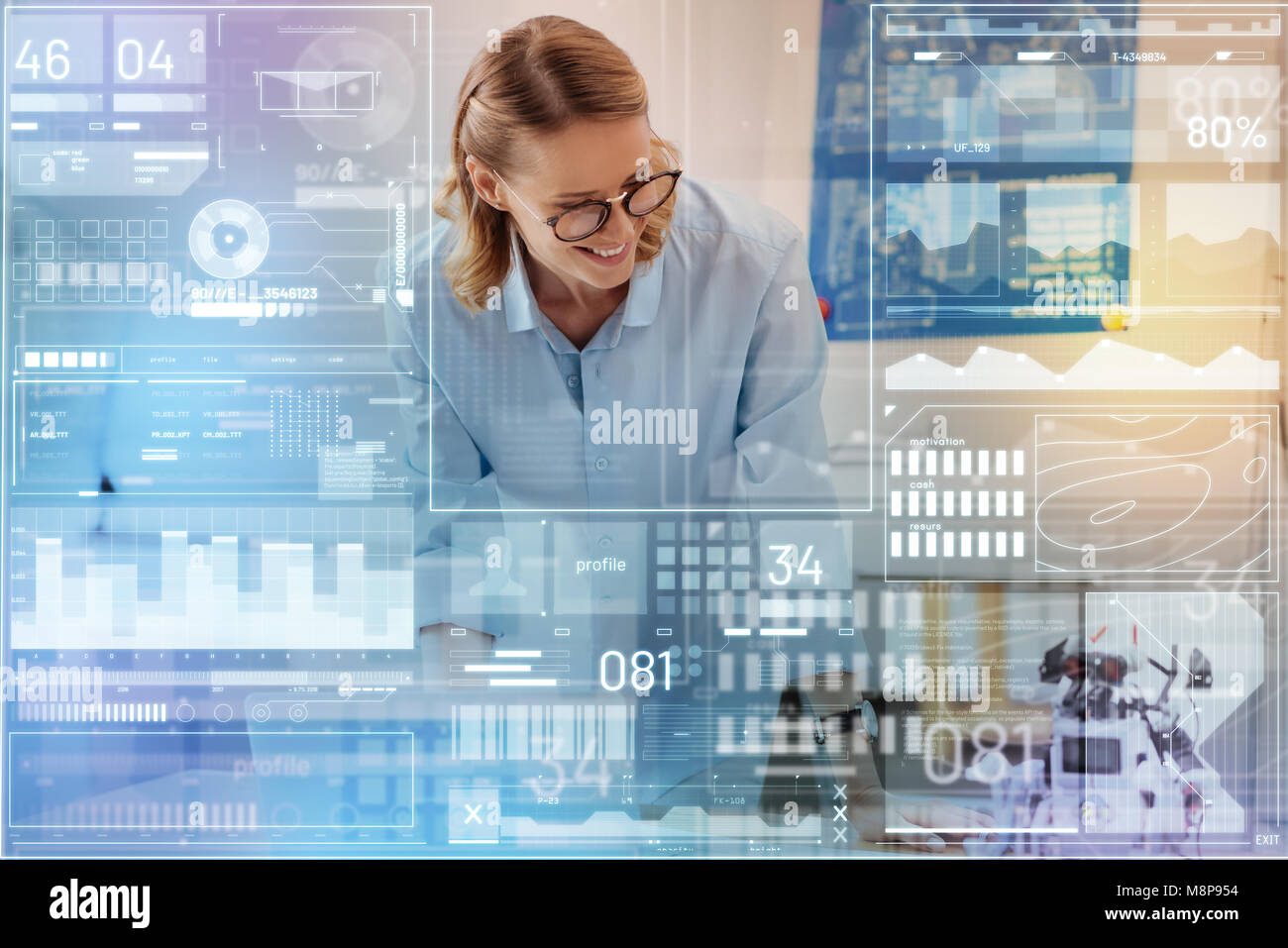 Positive engineer feeling happy while looking at her real robot Stock ...