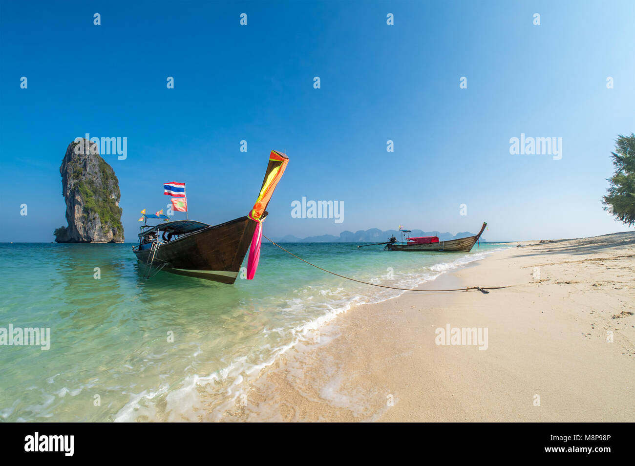 Traditional long-tail boat on the beach Stock Photo - Alamy