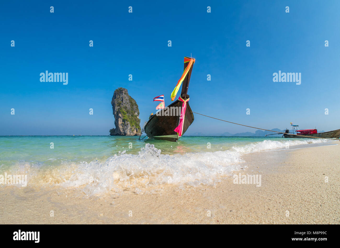 Traditional long-tail boat on the beach Stock Photo - Alamy