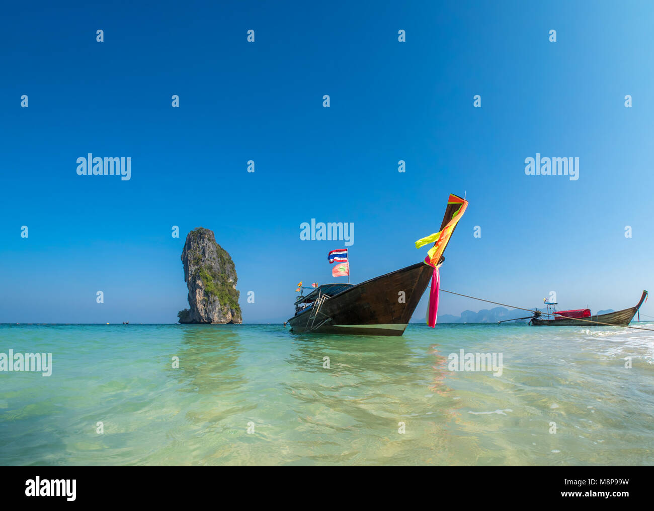 Traditional long-tail boat on the beach Stock Photo - Alamy