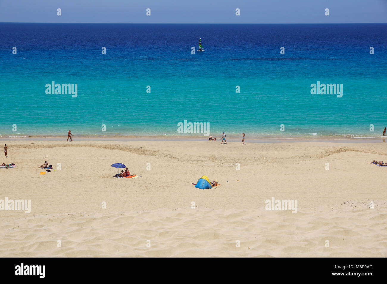 Sand dune and coastal promenade along a beach in Morro Jable town ...