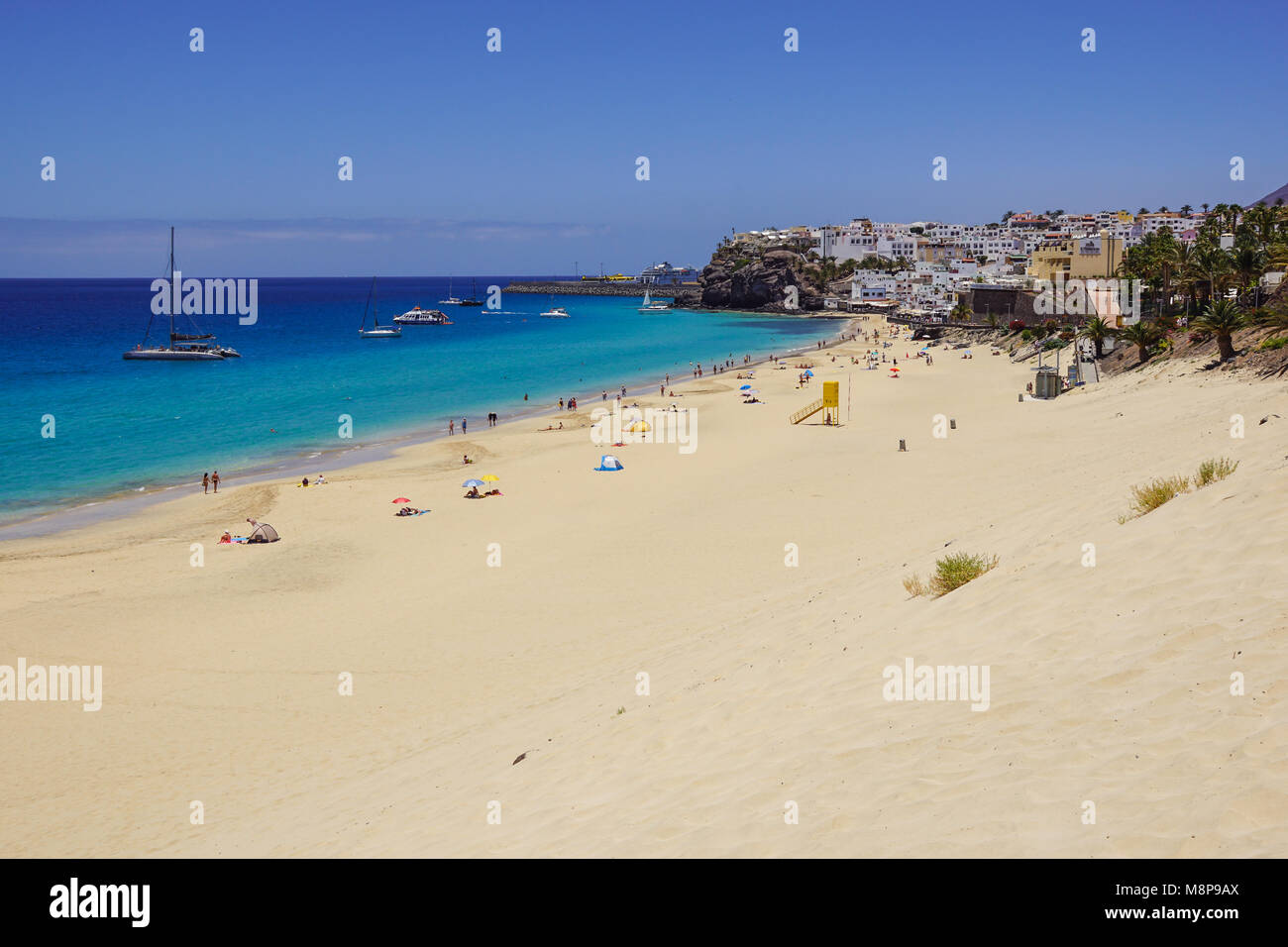 Sand dune and coastal promenade along a beach in Morro Jable town ...