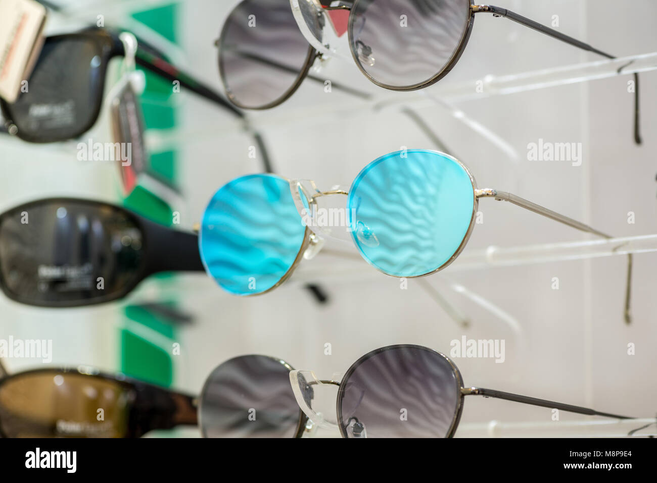 a variety of medical and sunglasses on the stand in the store Stock ...