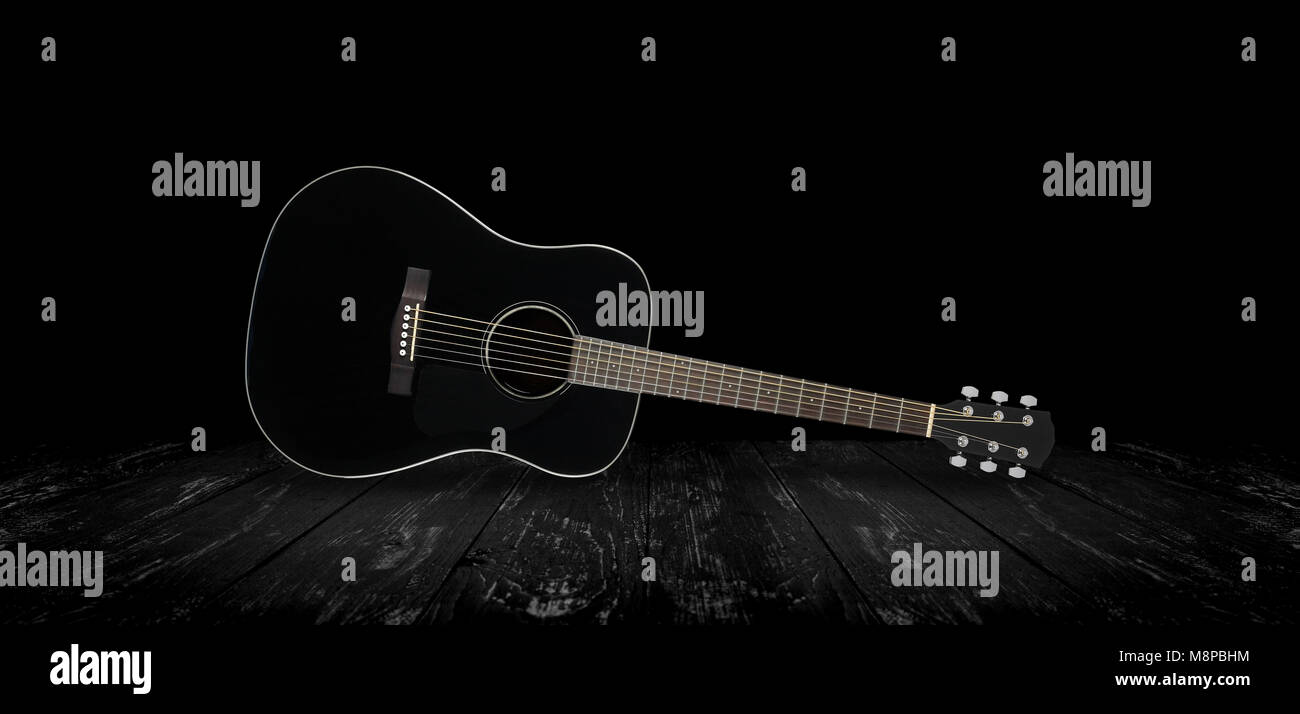 Musical instrument - Black acoustic guitar on black background Stock ...