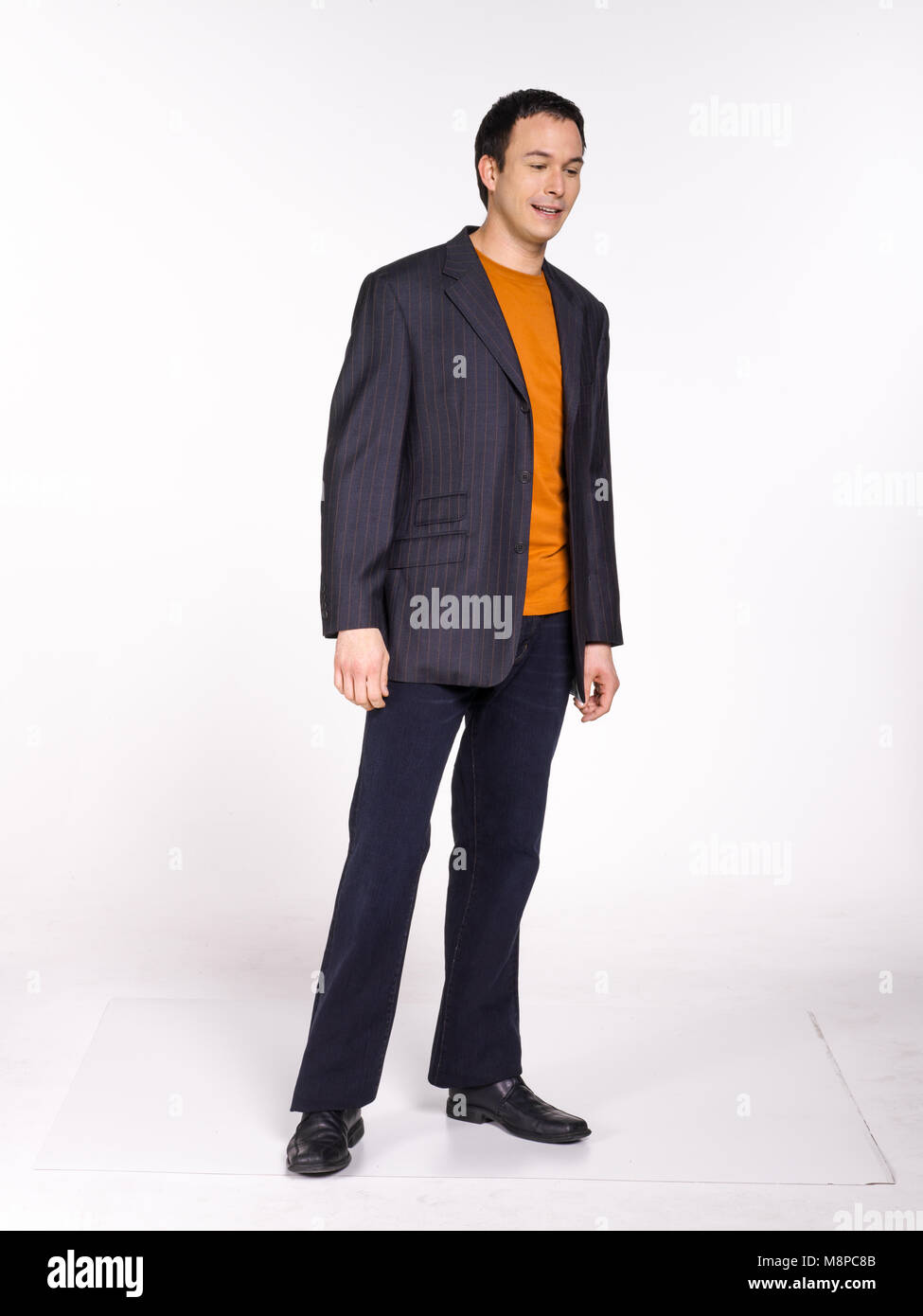 Studio portrait of young white male/man with dark hair against light ...