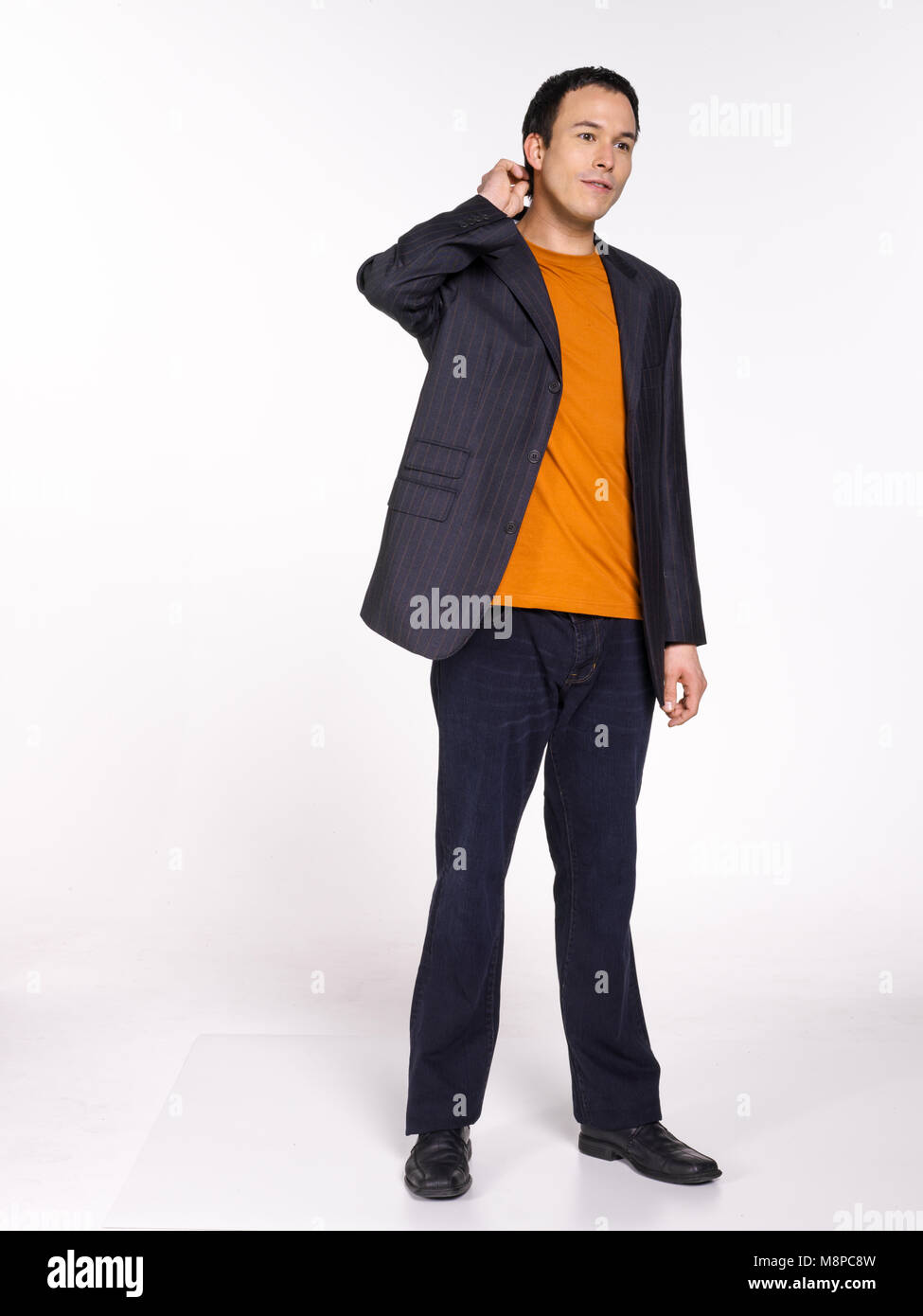Studio portrait of young white male/man with dark hair against light ...