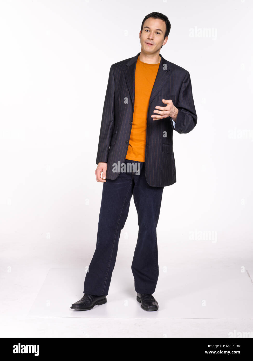 Studio portrait of young white male/man with dark hair against light ...