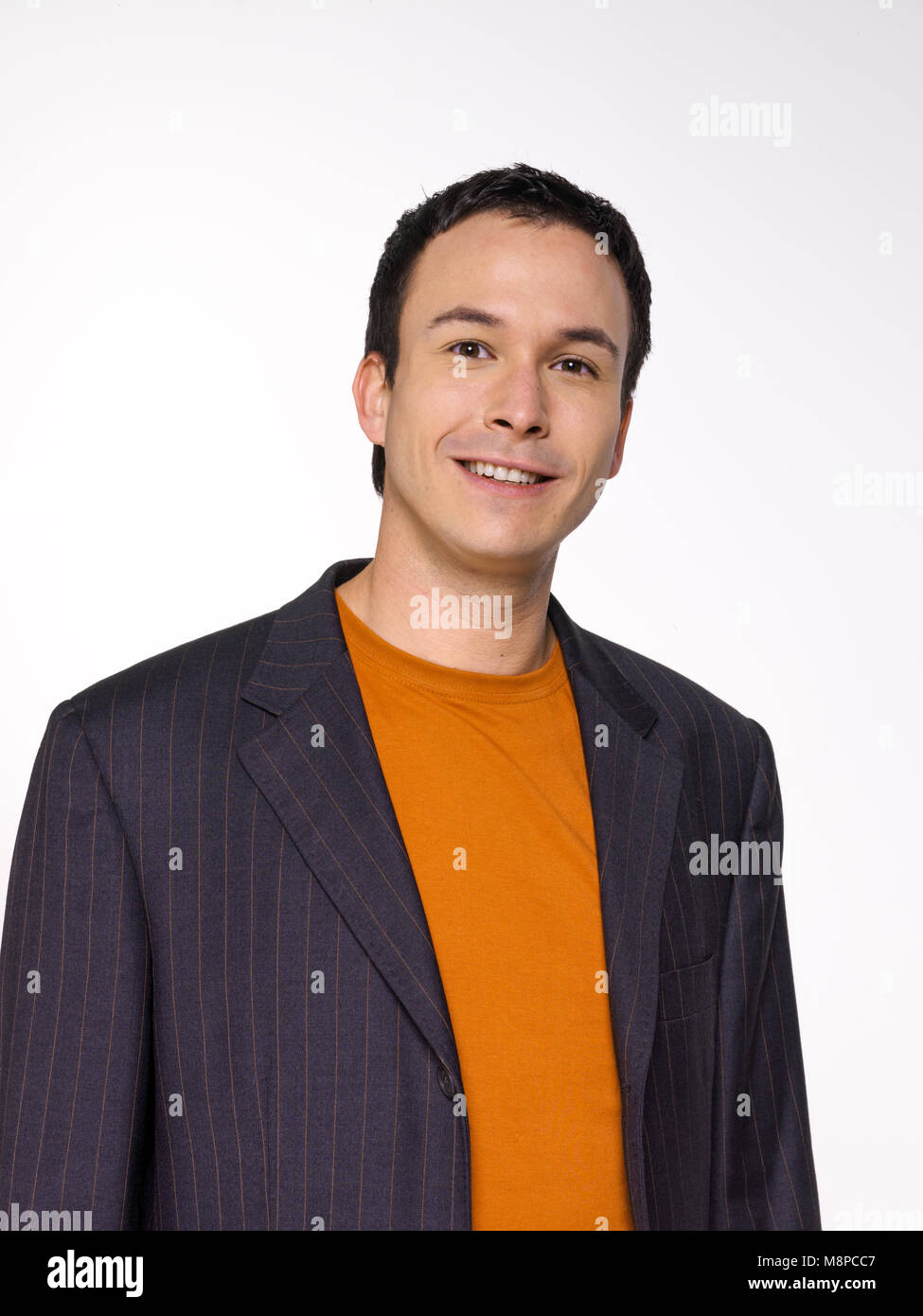 Studio portrait of young white male/man with dark hair against light ...