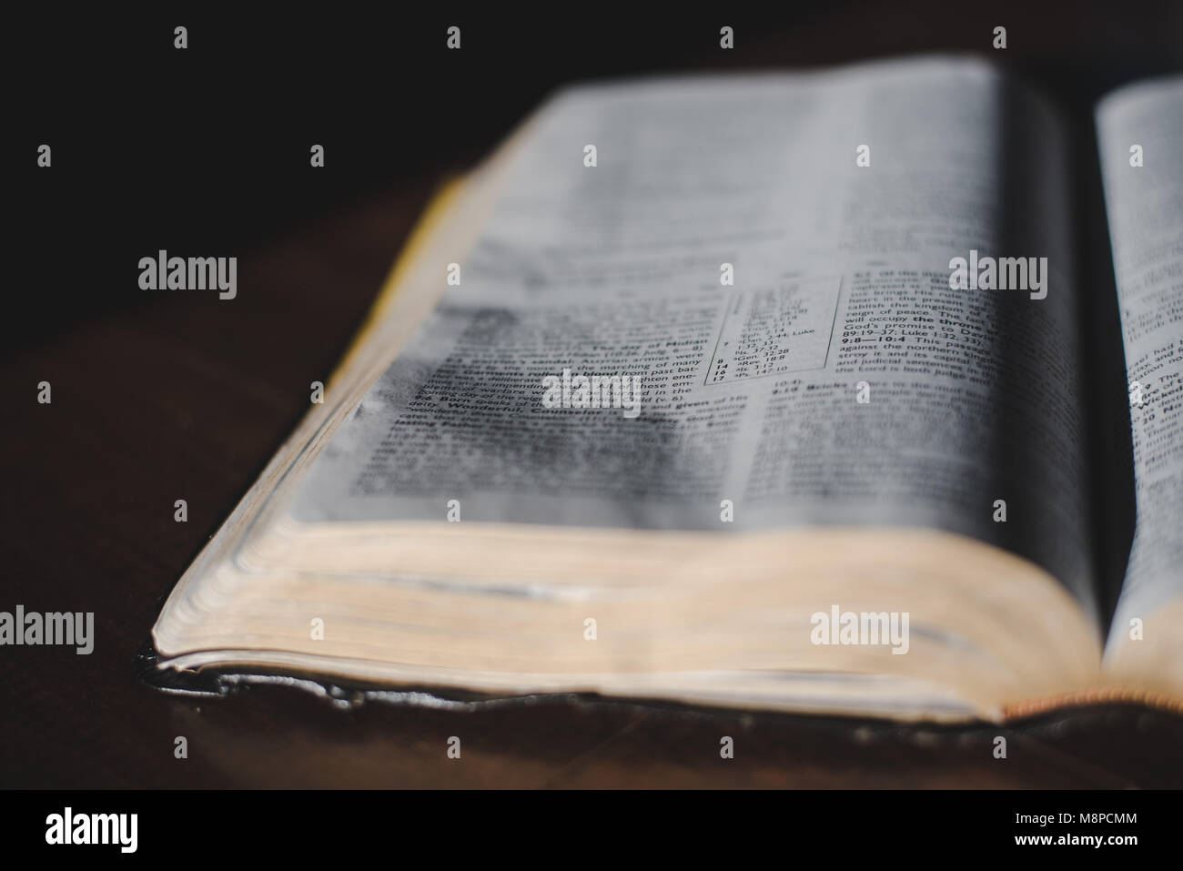 A Bible laying open on a table Stock Photo - Alamy