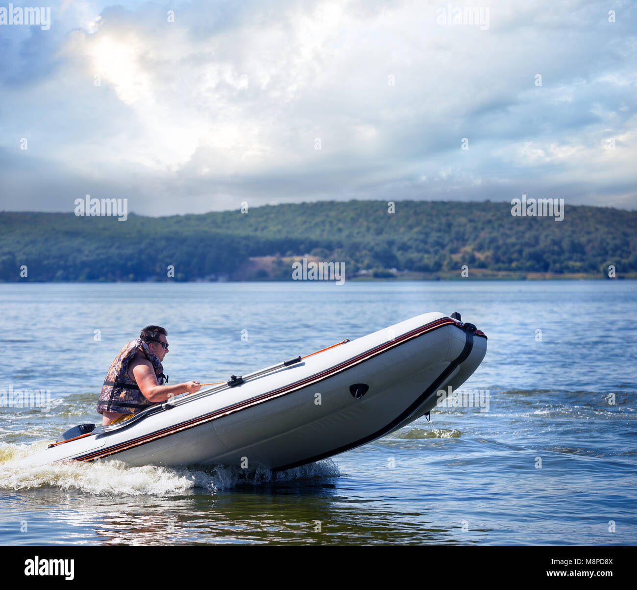 Man running white motor boat with orange stripes on the sides Stock ...