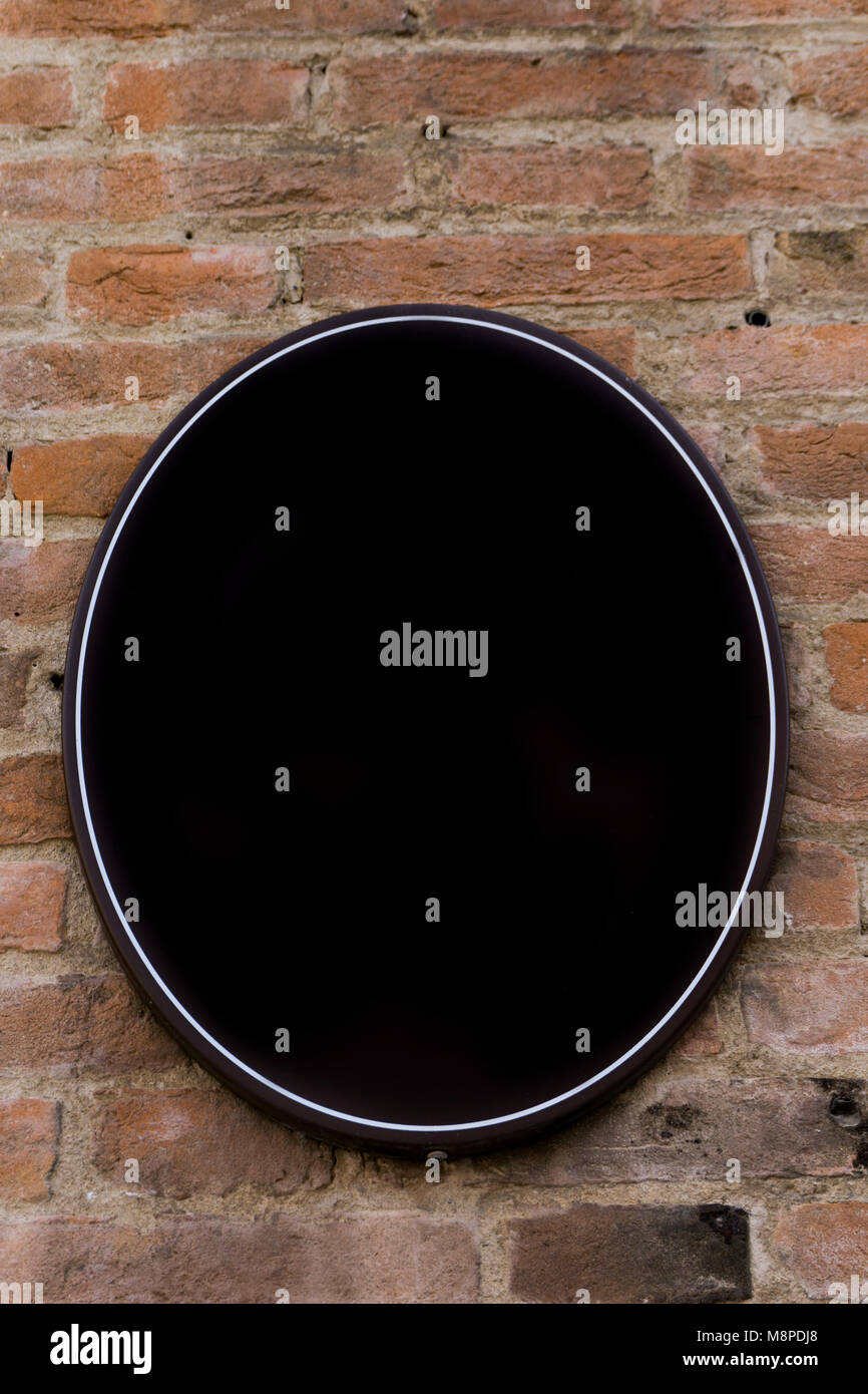 Empty oval sign with copy space on the old brick wall Stock Photo - Alamy