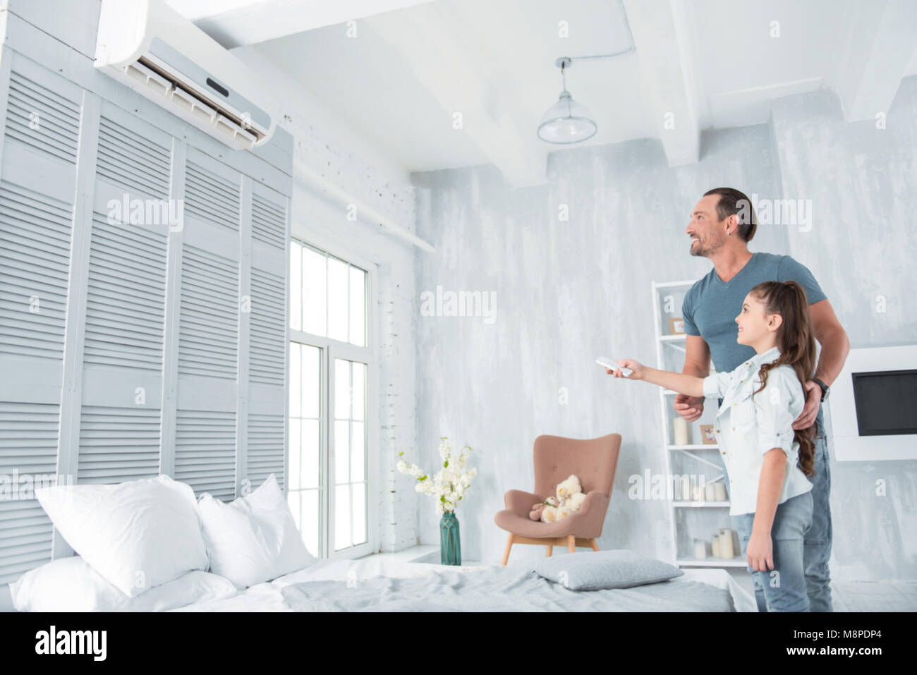 Joyful girl holding remote control hi-res stock photography and images ...