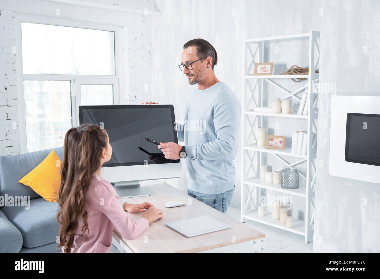 Delighted positive man pointing at the screen Stock Photo - Alamy