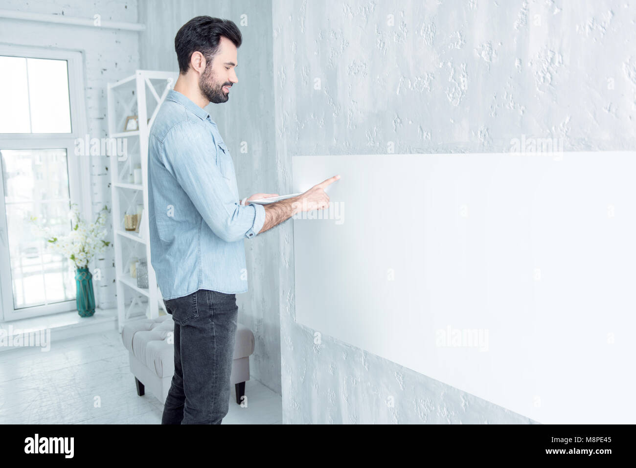 Attractive brunette male standing in semi position Stock Photo - Alamy
