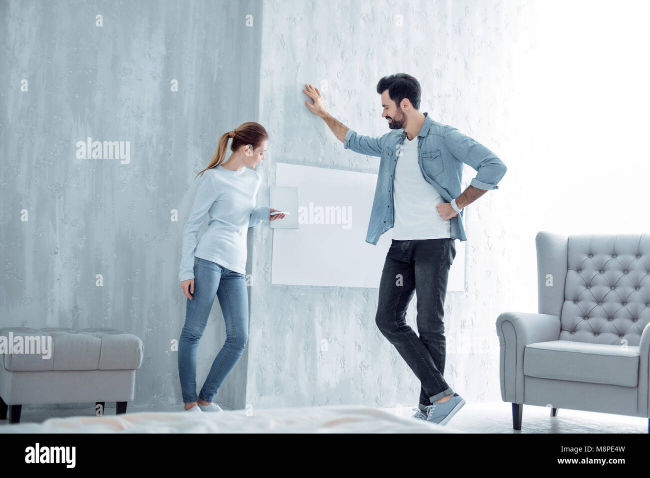 Attractive male person leaning on wall Stock Photo - Alamy