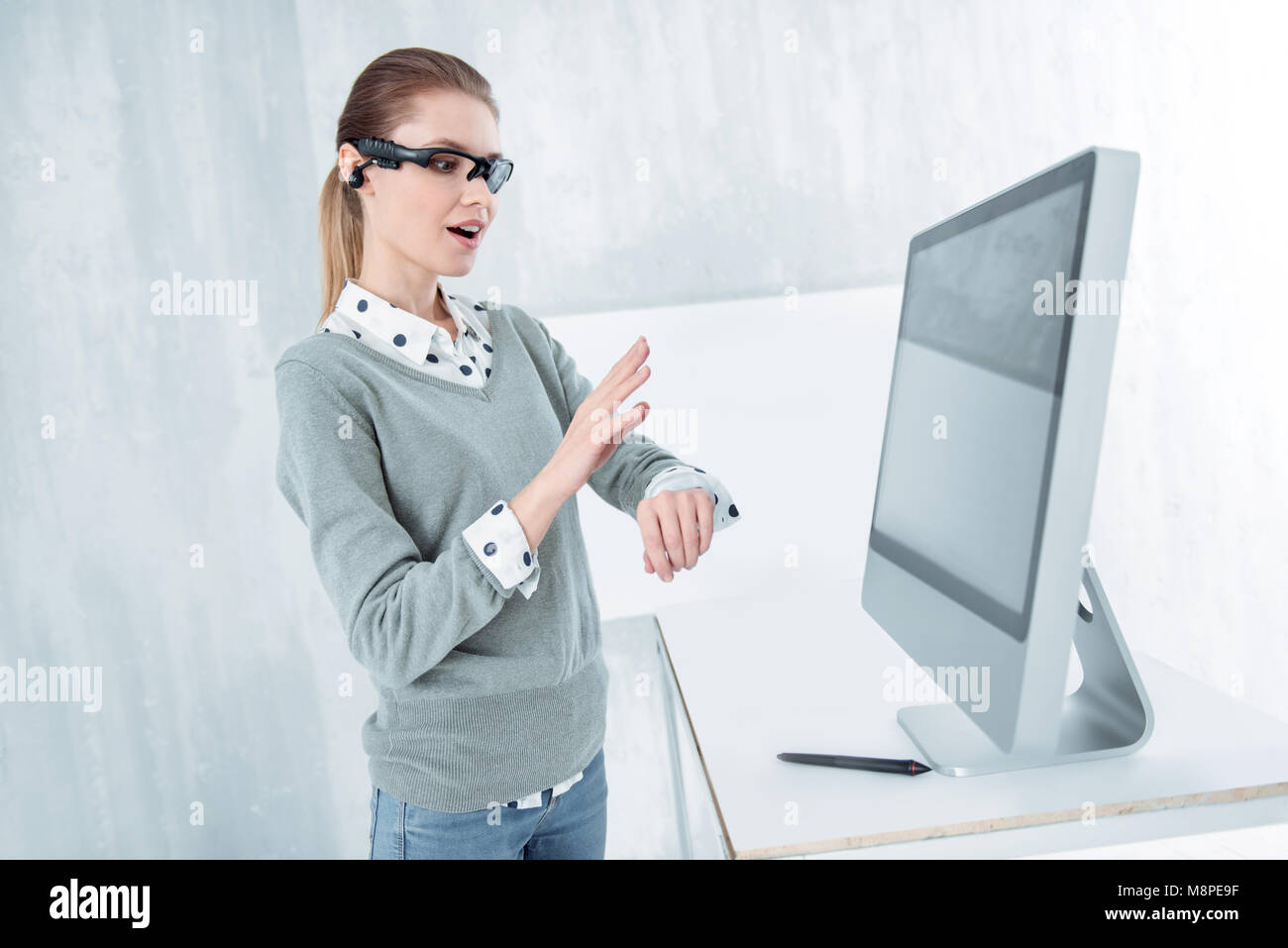 Surprised female person staring at her gadget Stock Photo - Alamy