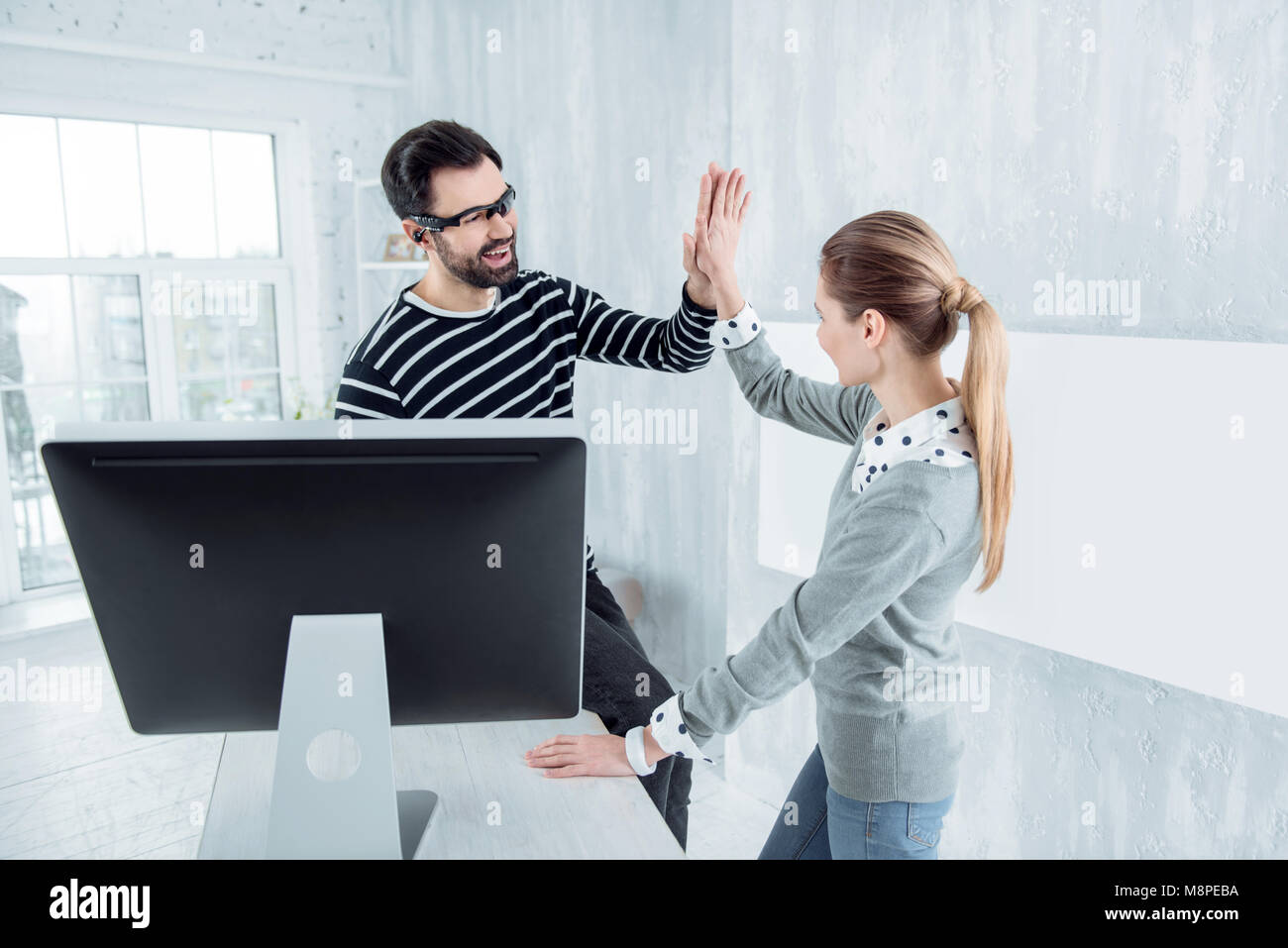 Happy young people touching hands Stock Photo - Alamy